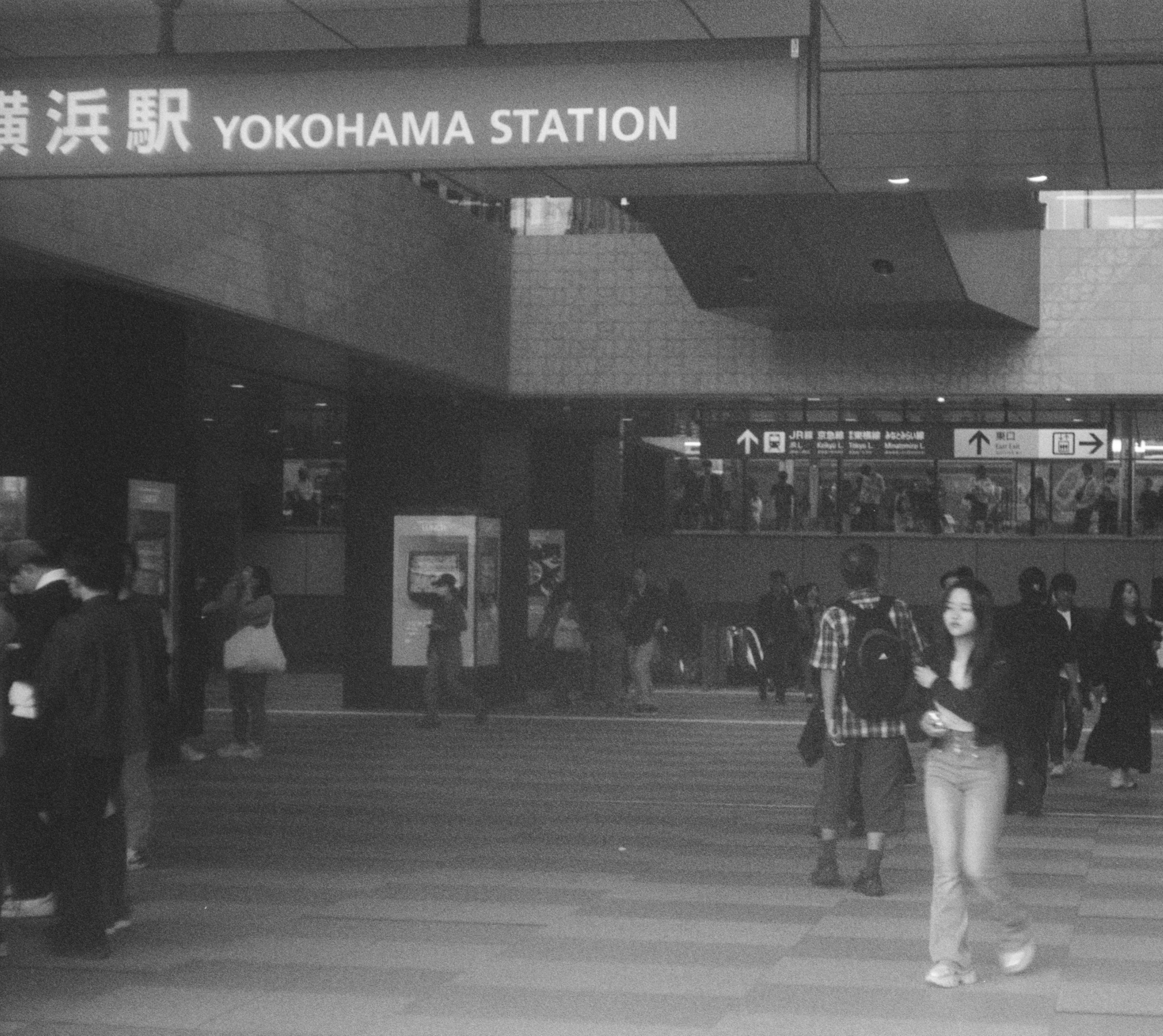 Girl navigates Yokohama Station in Yokohama, Japan. Taken in 2025 with my father's Samoca 35mm camera from his service in Korea and Japan in the 1950s. Cinestill film.