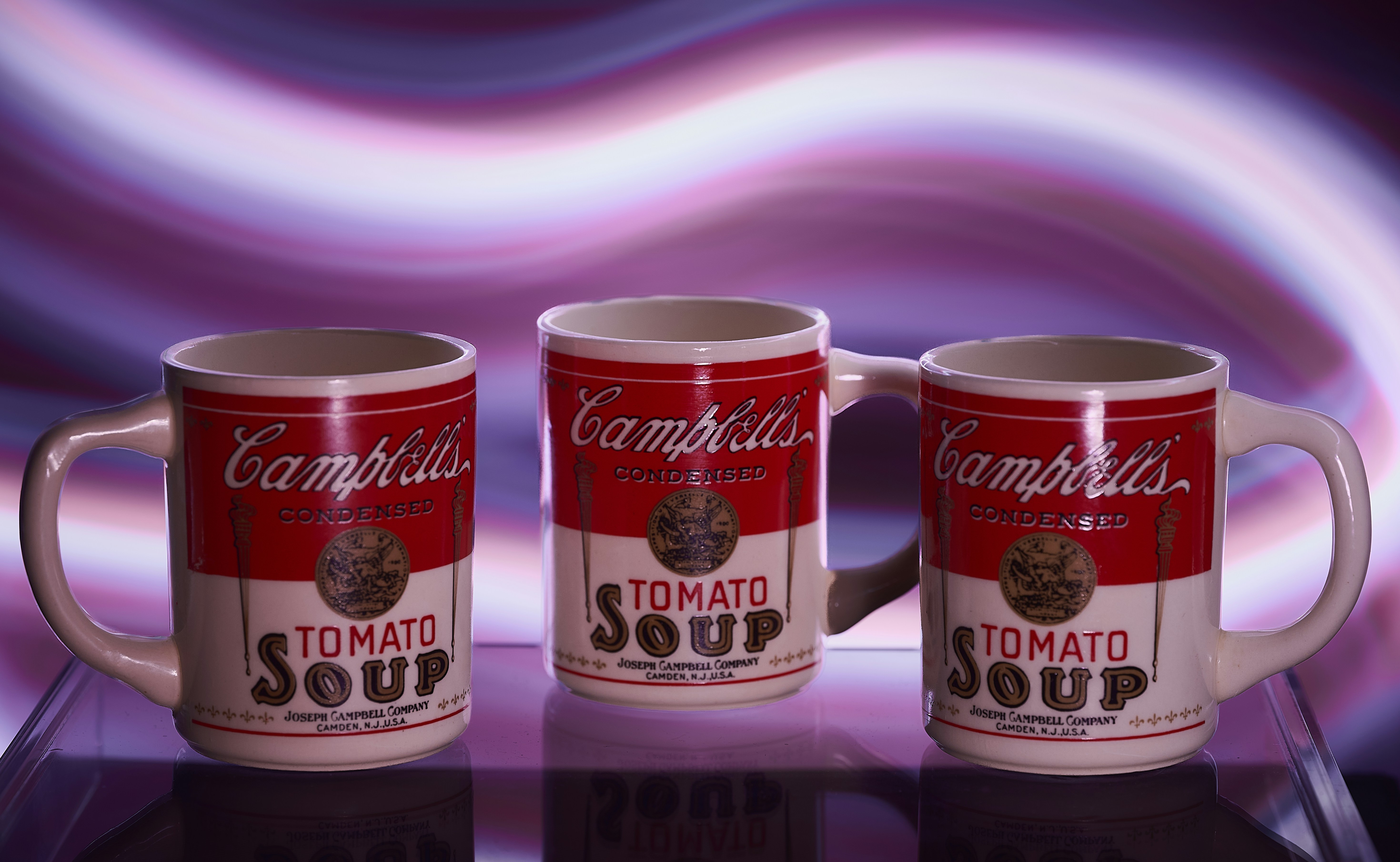Three Campbell’s Mugs Align: Tomato Soup Still Life with Neon Wave Backdrop