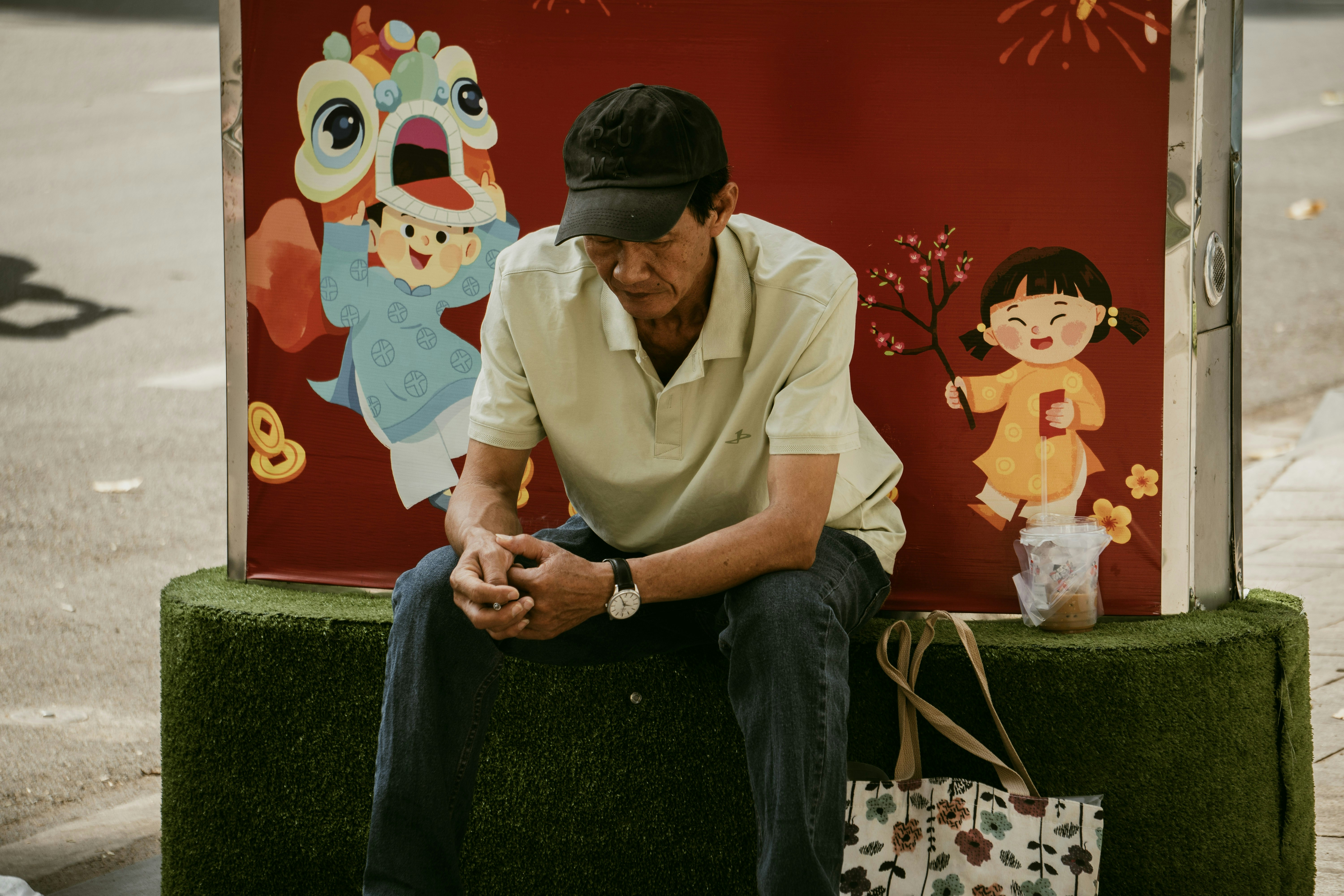 Grounded Moment: A Street Vendor Pauses Amid Colorful Backdrop