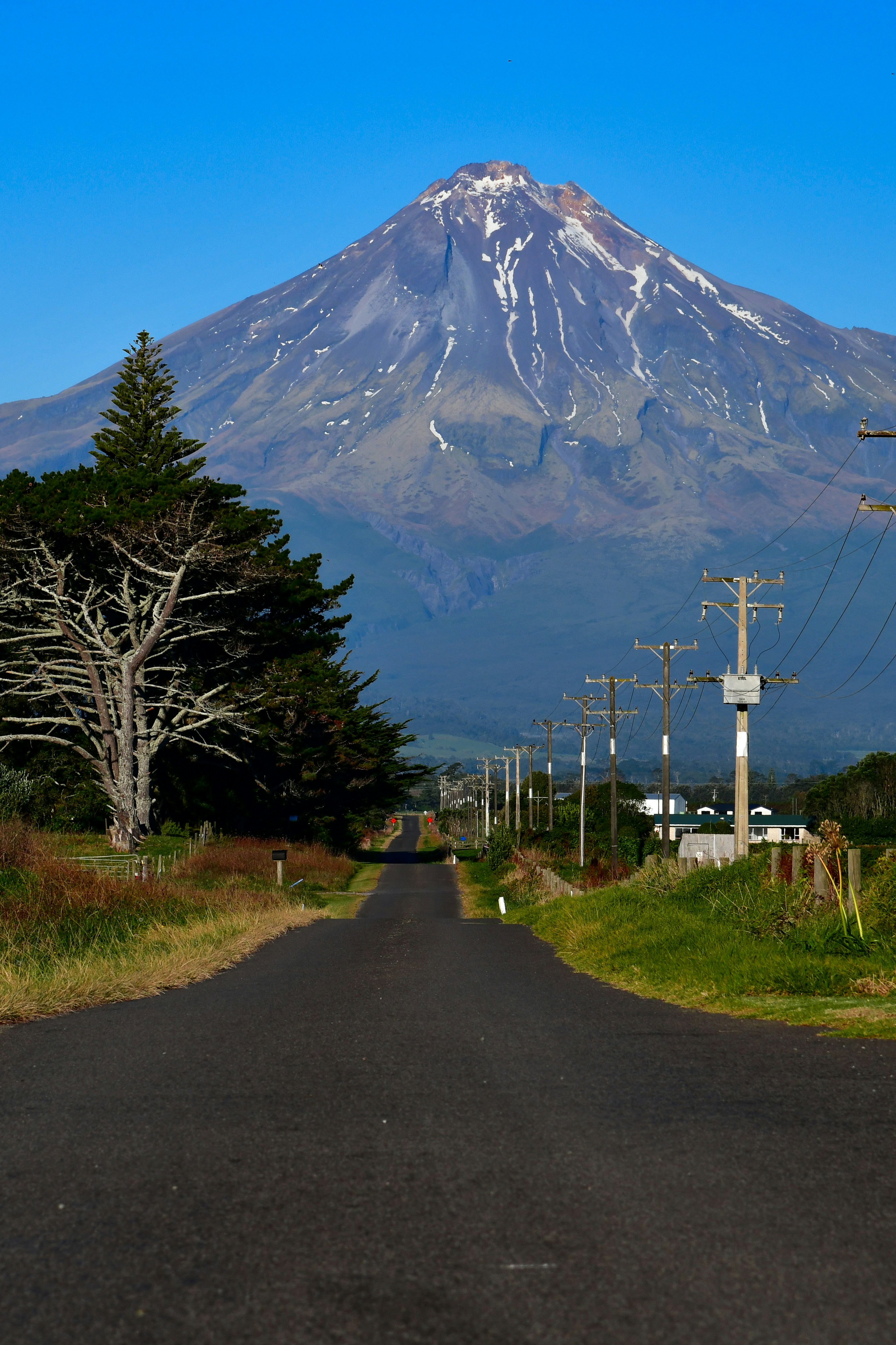 Road Toward the Peak: A Mountain Highway Framed by Power Lines