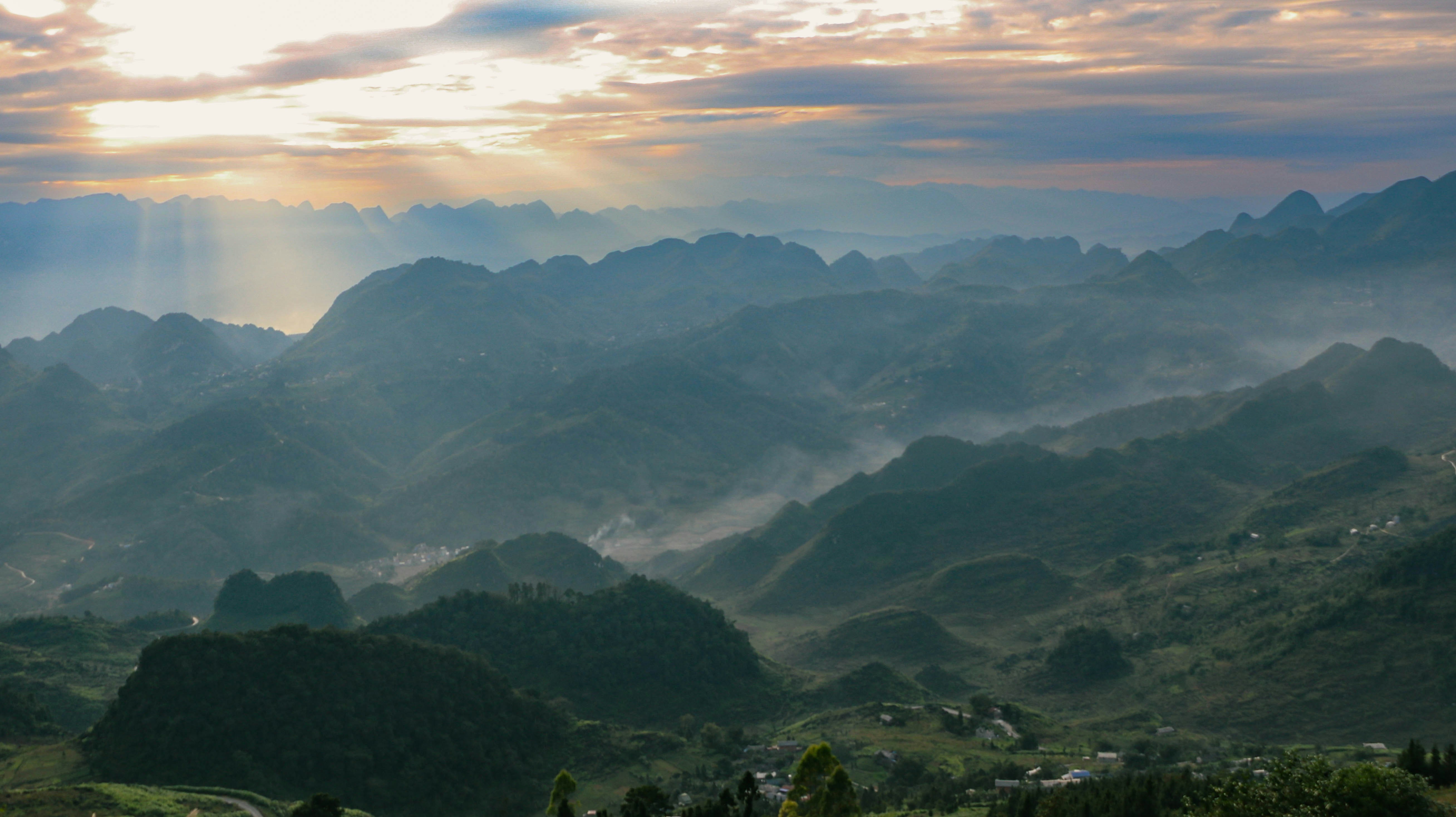 Dawn over the Misty Valley: A Layered Mountain Vista