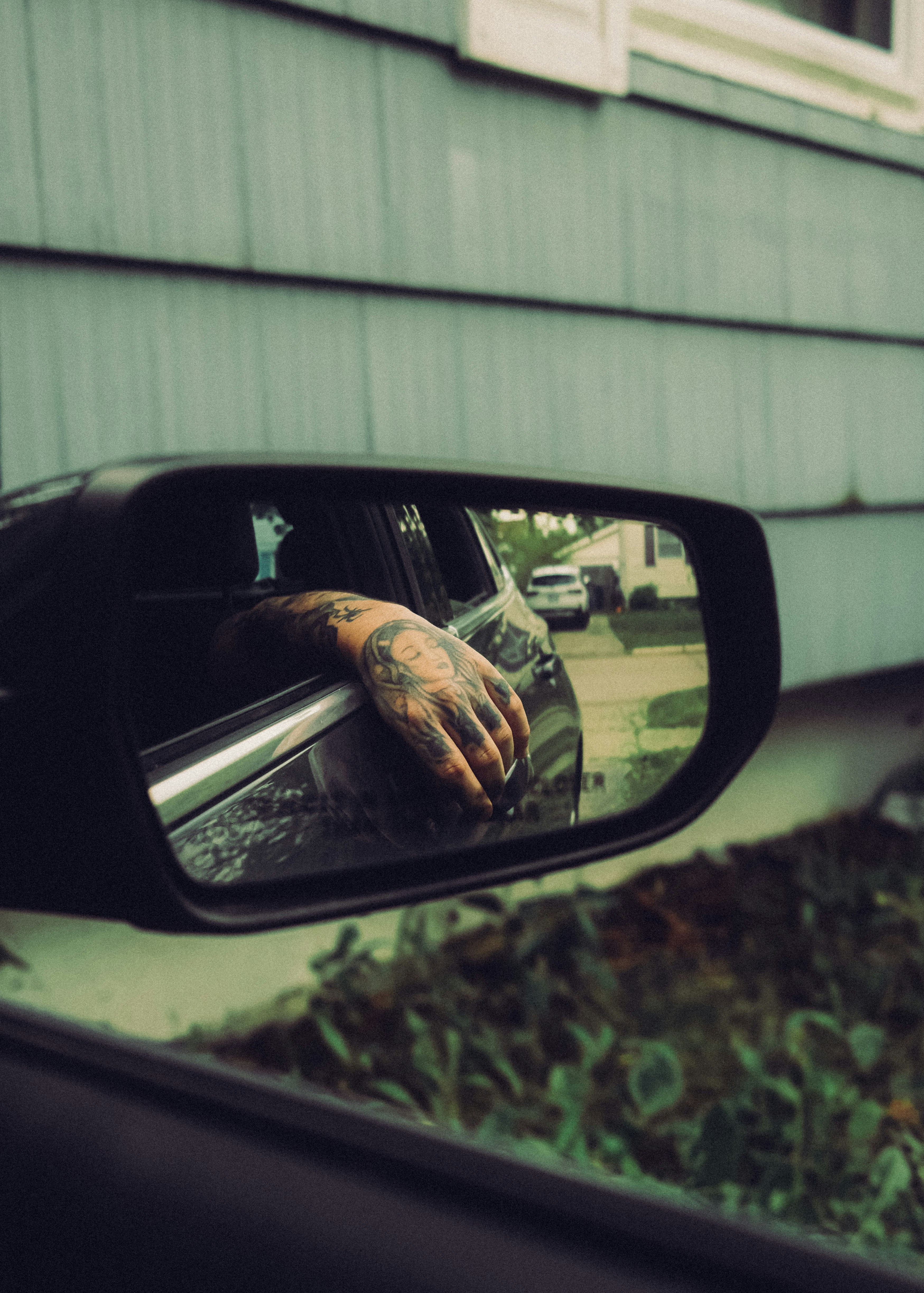 Tattooed Grasp in the Car Mirror