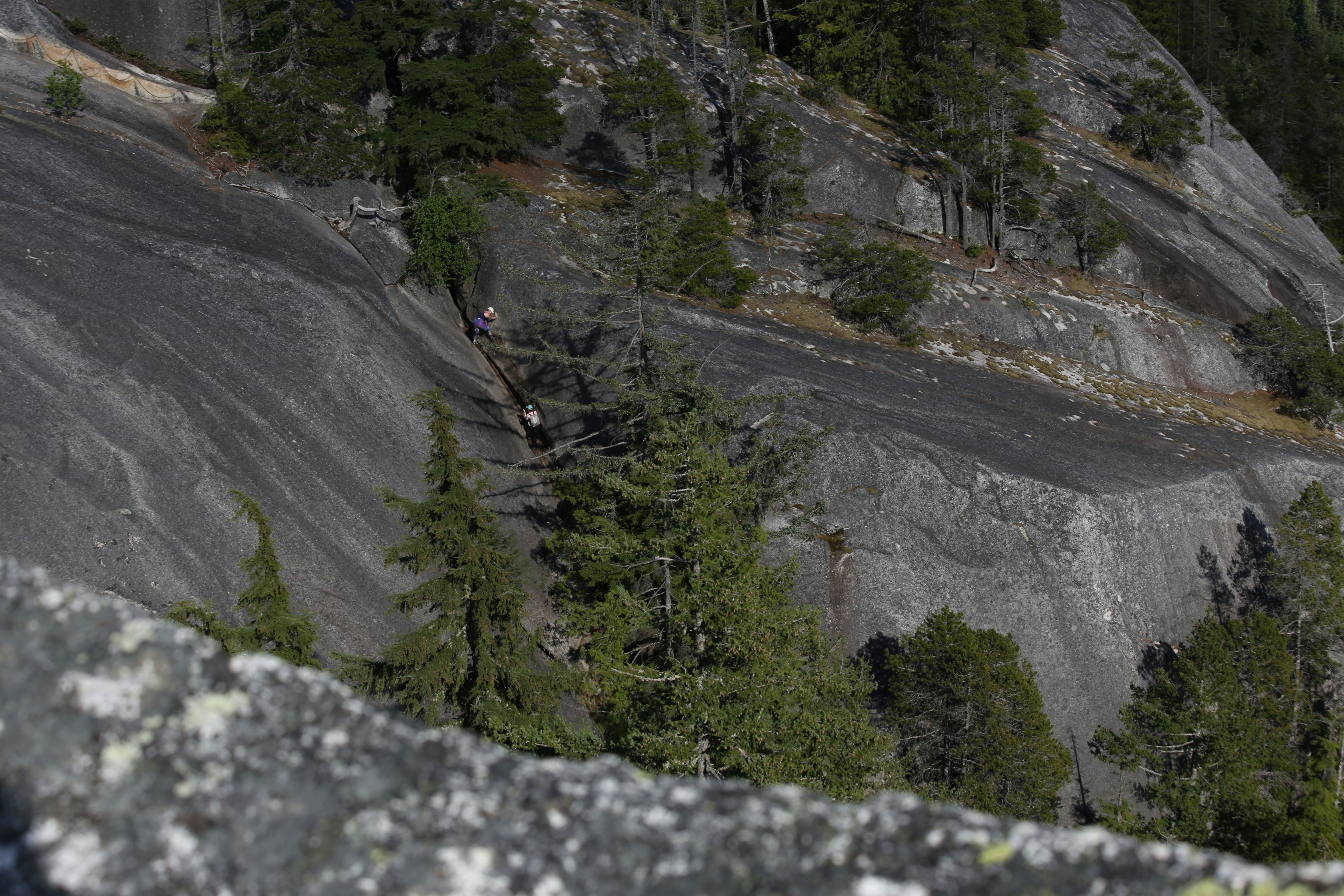 Cliffside Ascent: Climbers against a granite wall