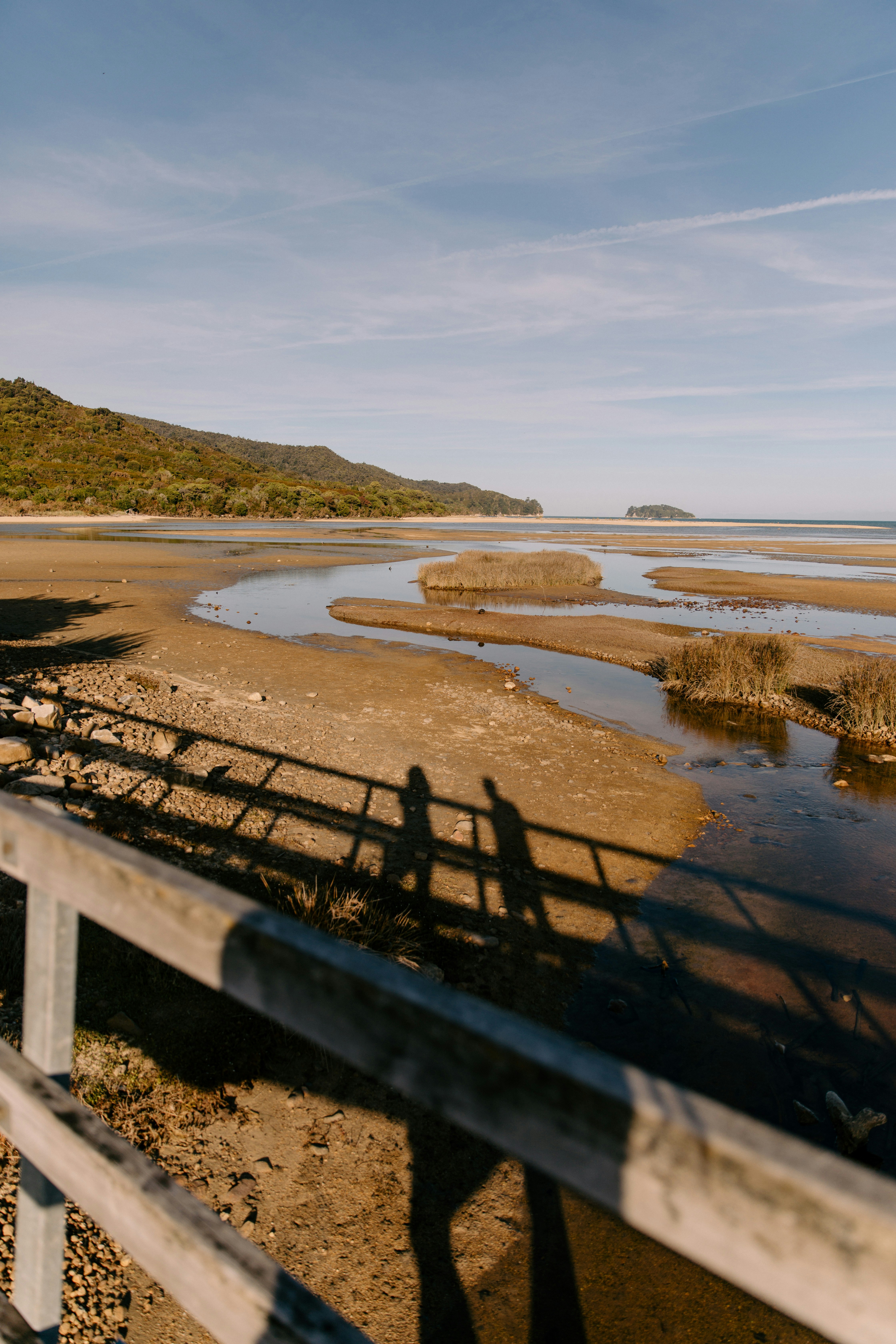 Shadowed Bridge Over Tidal Flats at Golden Hour