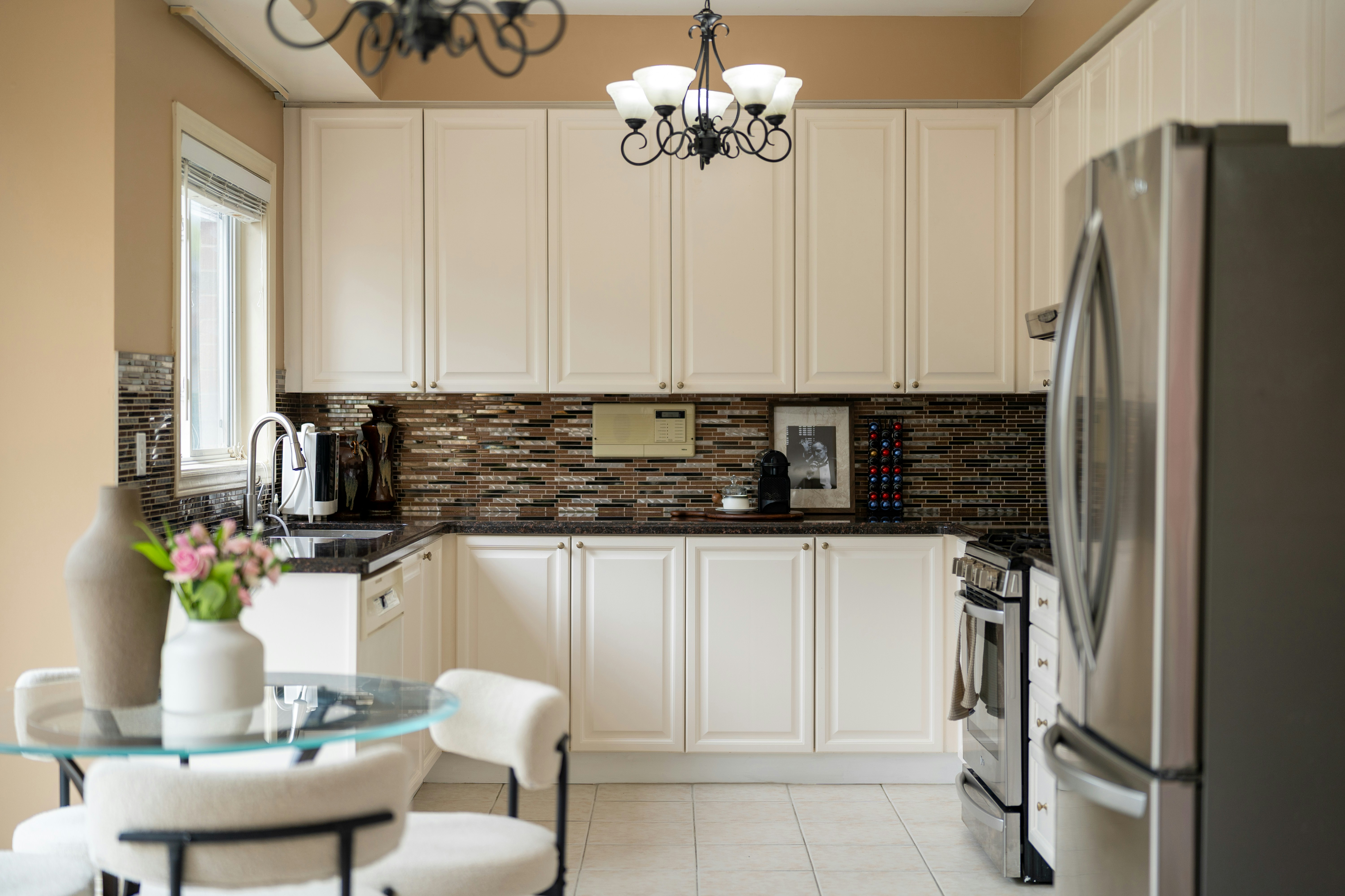 Bright Nook: A Modern Kitchen with Cream Cabinets and Mosaic Backsplash