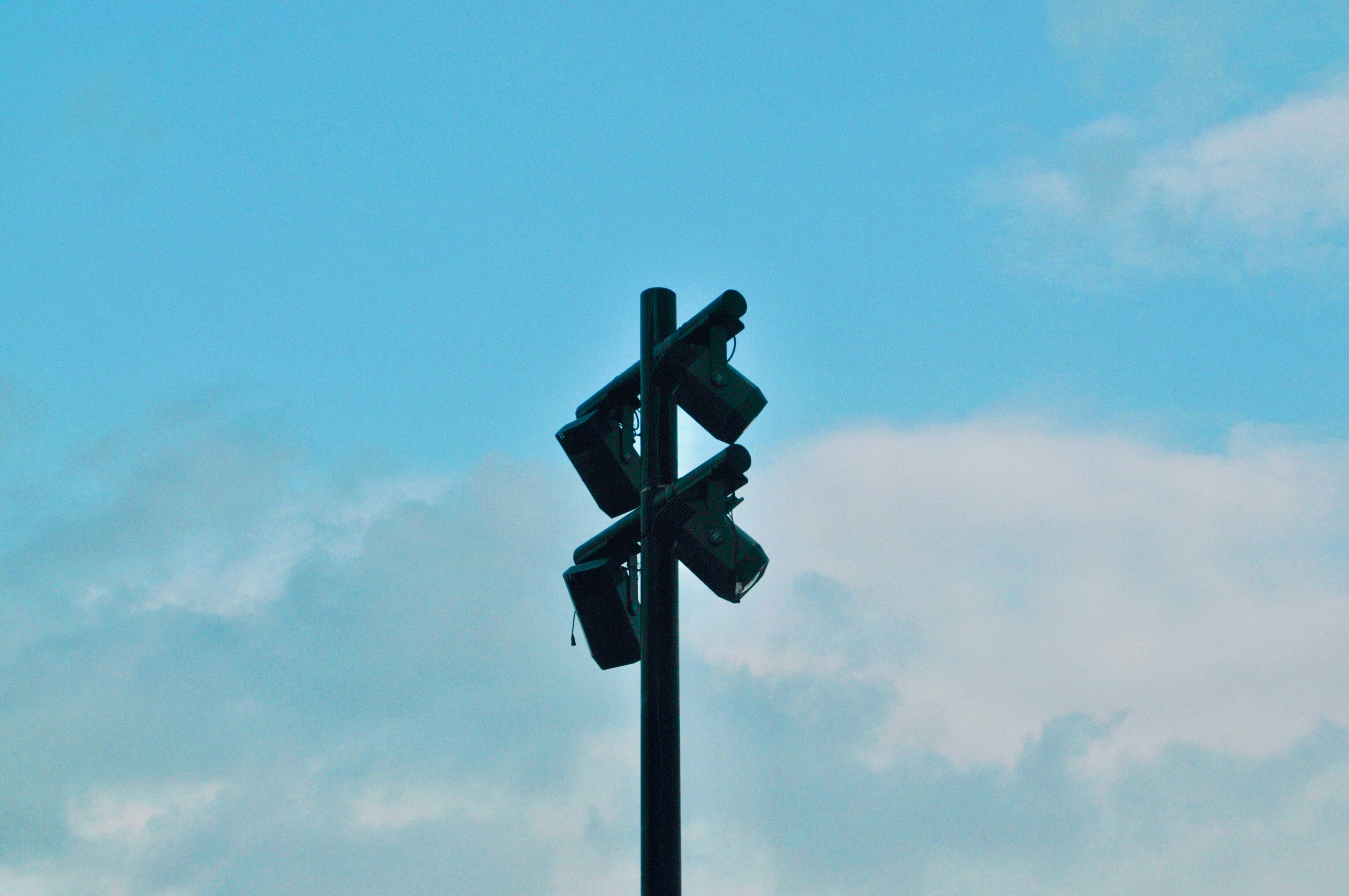Pole-mounted Signal Tower Reaching Toward a Clear Sky