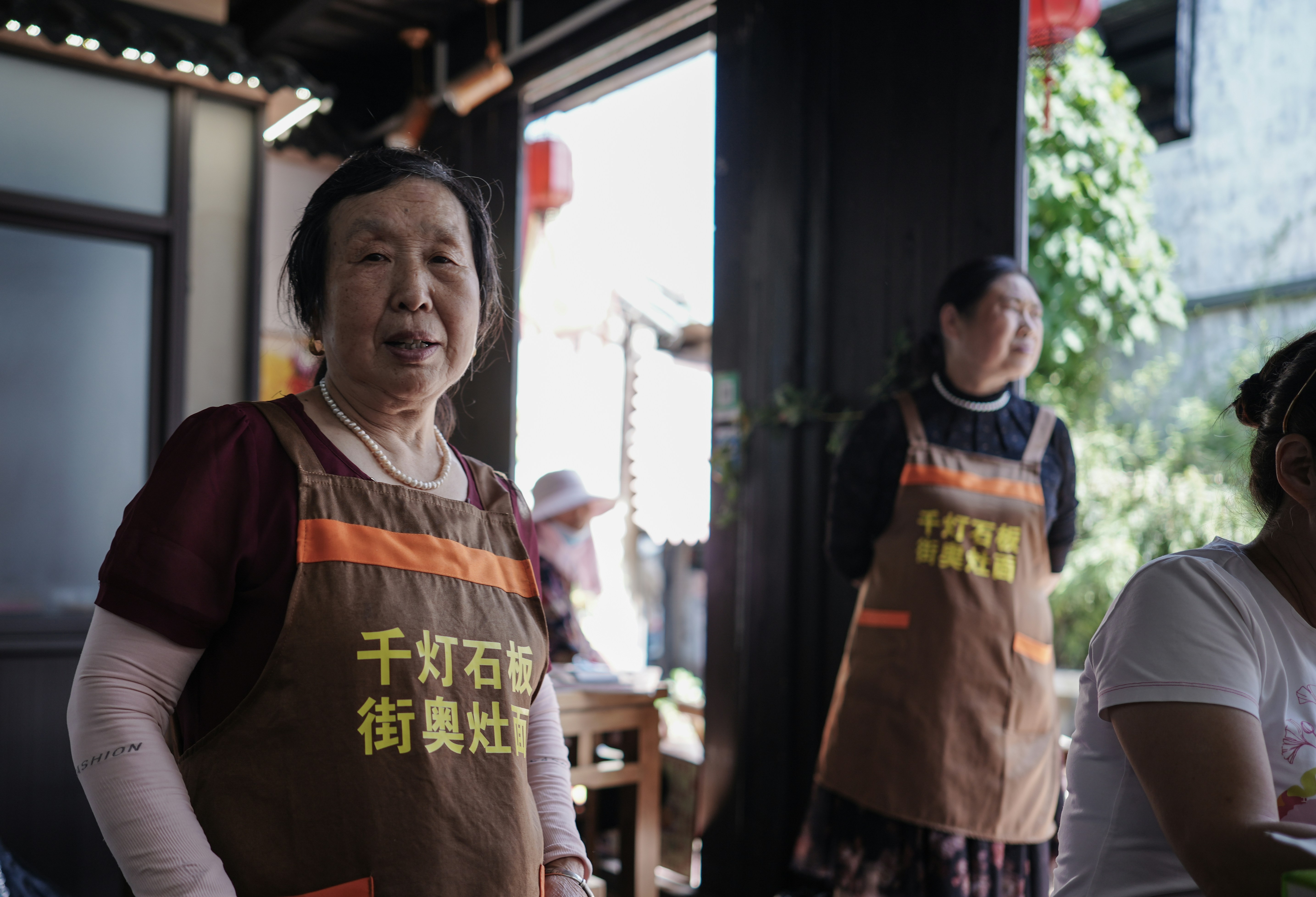 Apron-Clad Keepers at a Lantern Festival Entrance