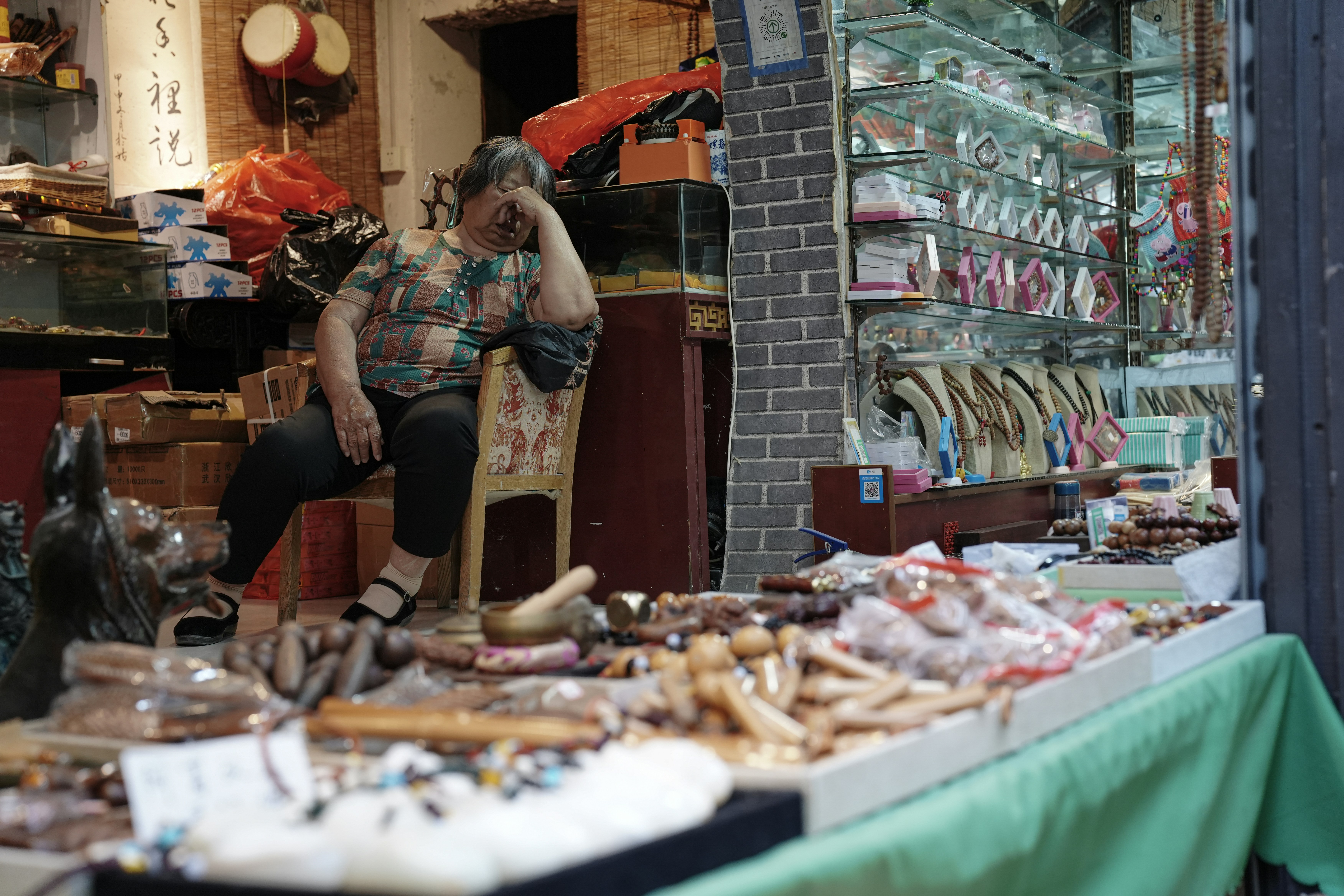 Resting Vendor Amid a Bountiful Bazaar of Handcrafted Treasures