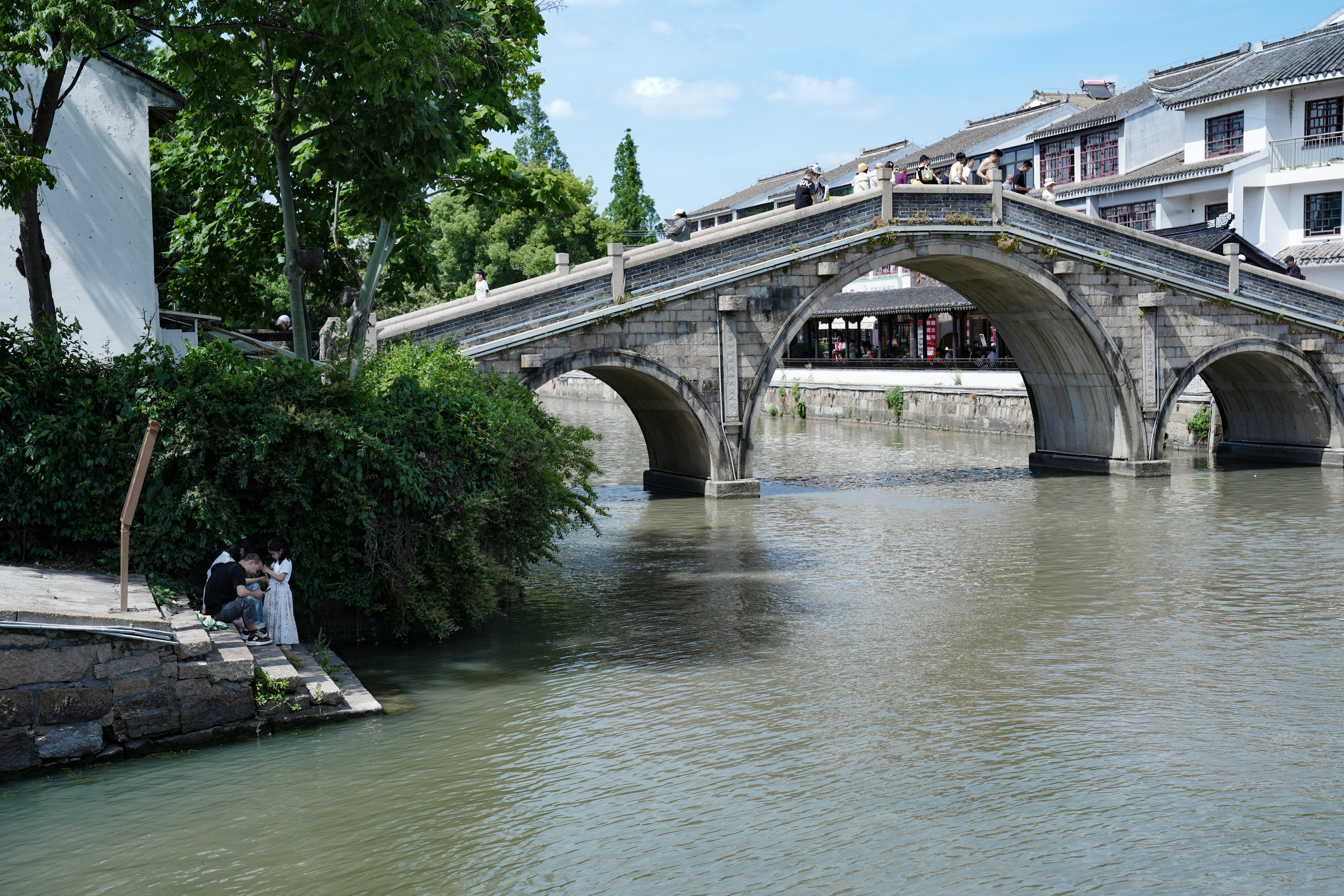 Arched Bridge Over Quiet River: A Snapshot of Morning Calm in a Historic Quarter
