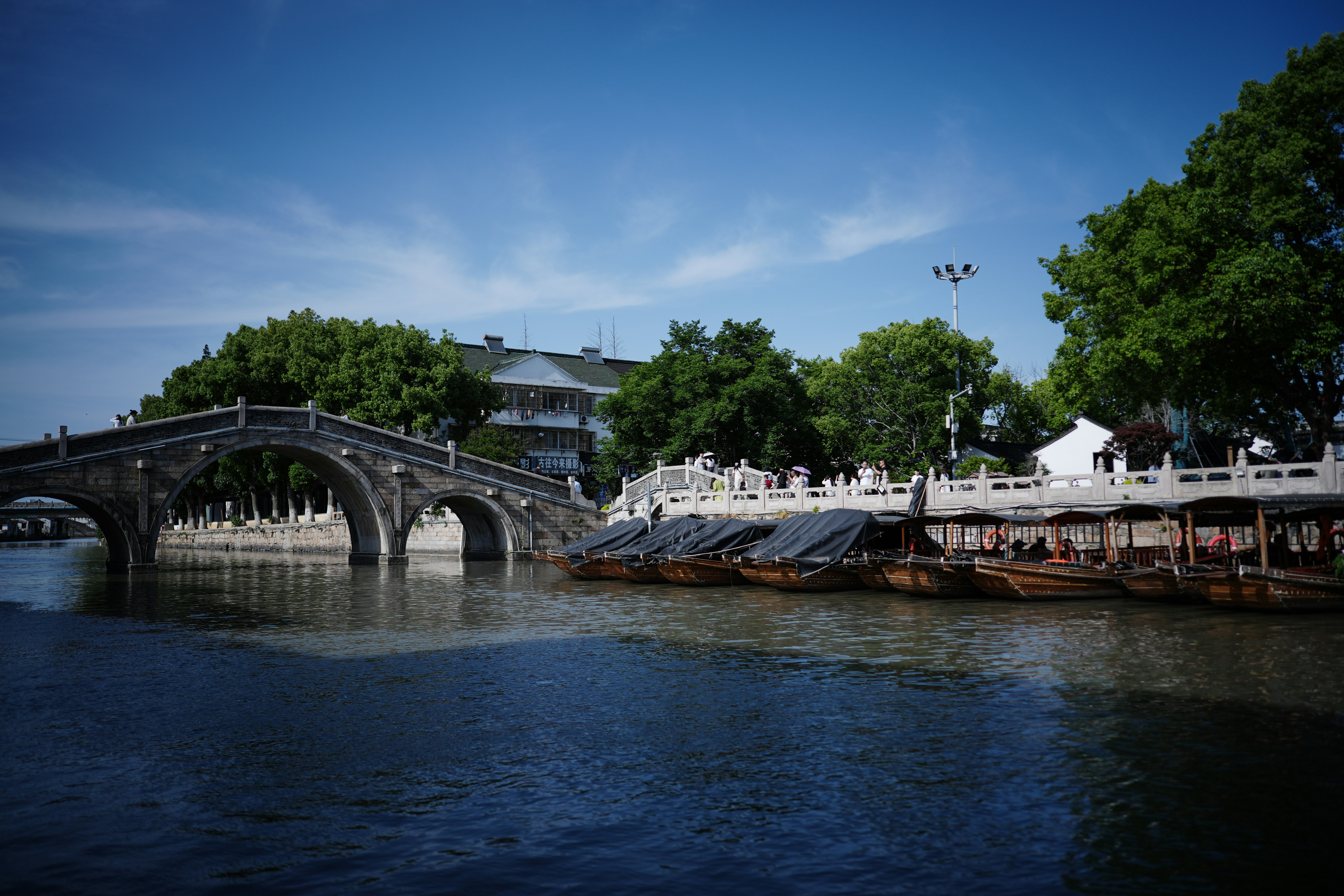 Stone Arc and Riverside Boats: a tranquil riverside scene