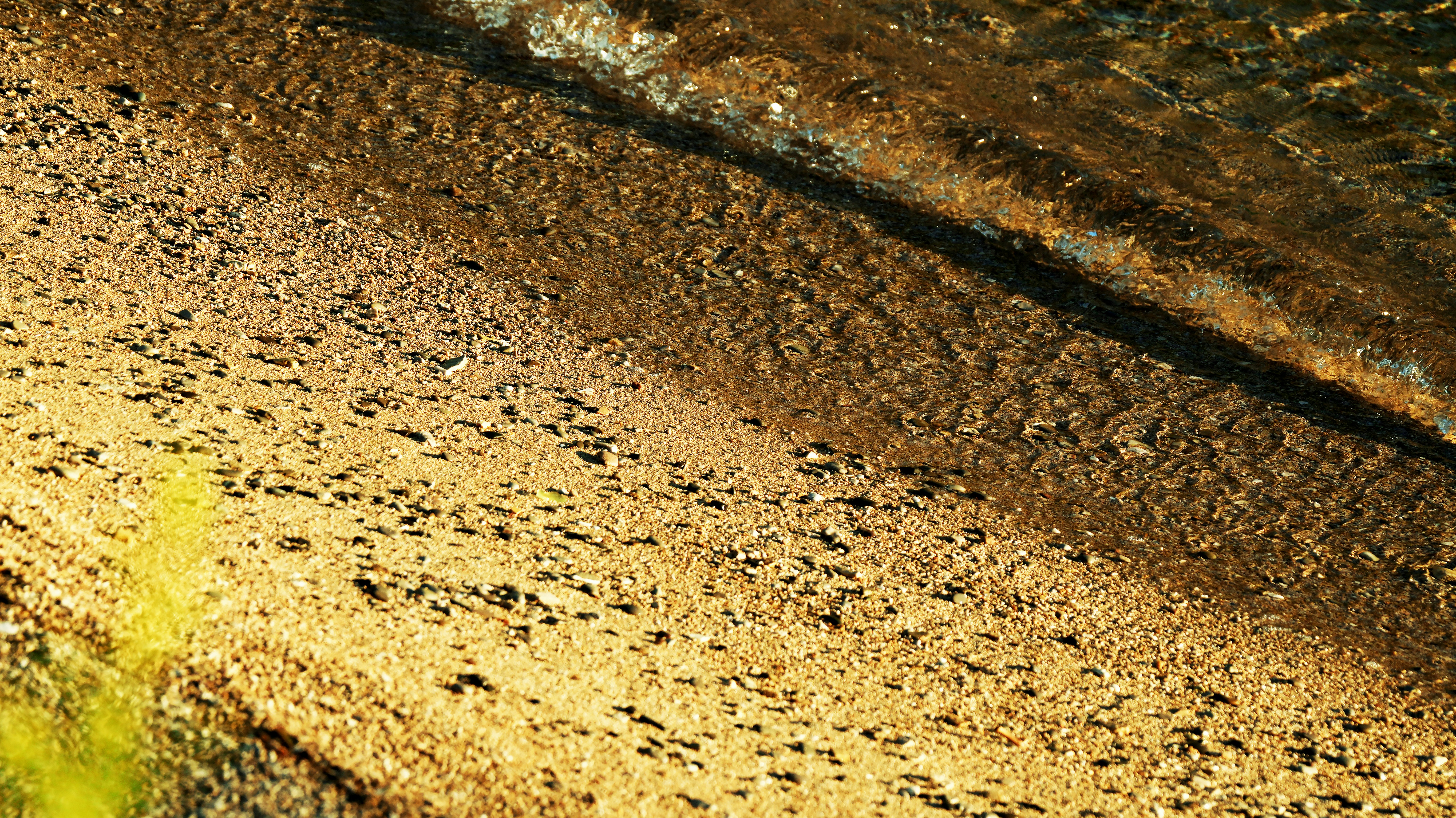 Pebble Mosaic by the Shore: Golden Sand and Sea Line