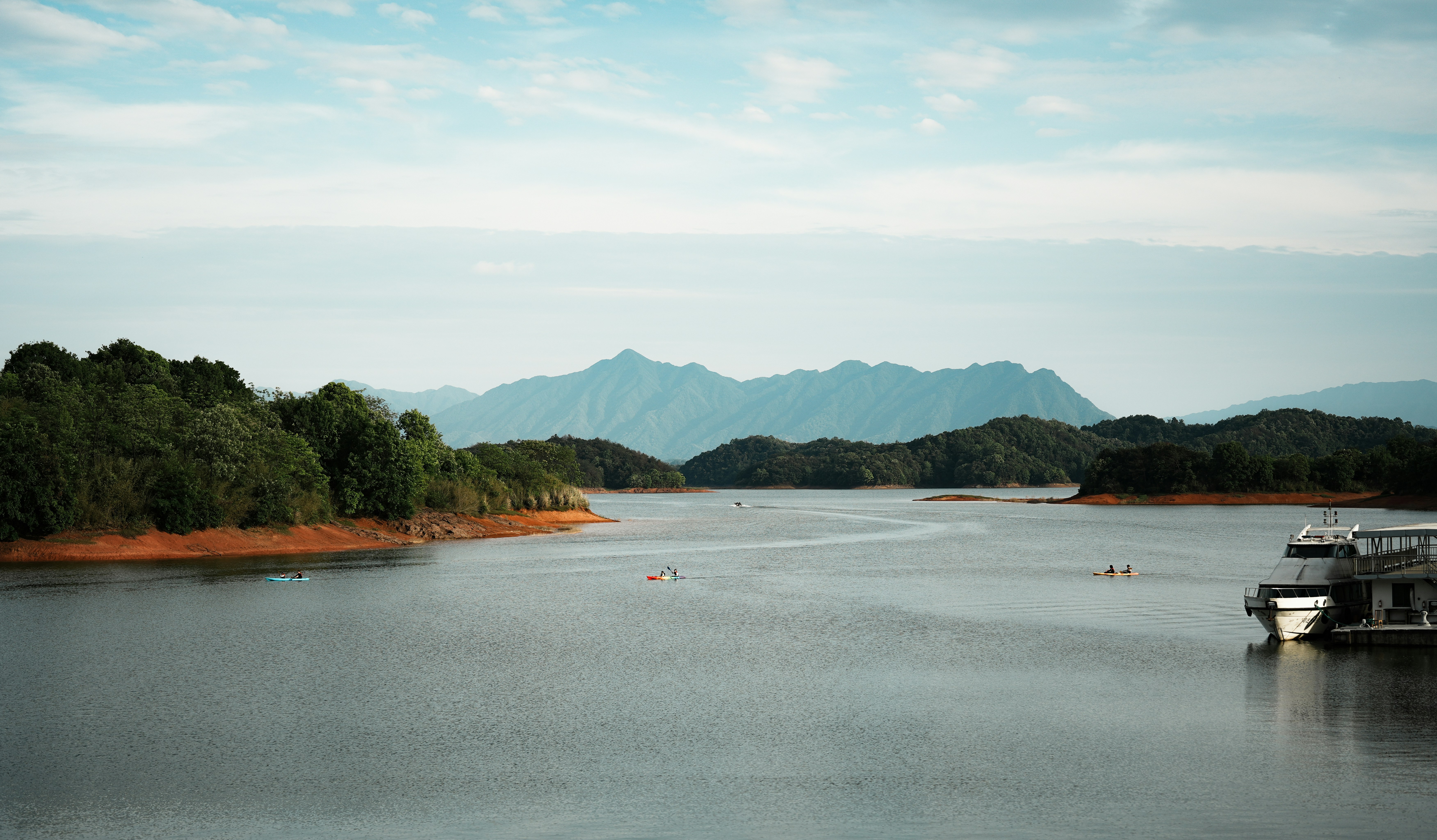 Quiet Reservoir at Dusk with Distant Mountain Chain