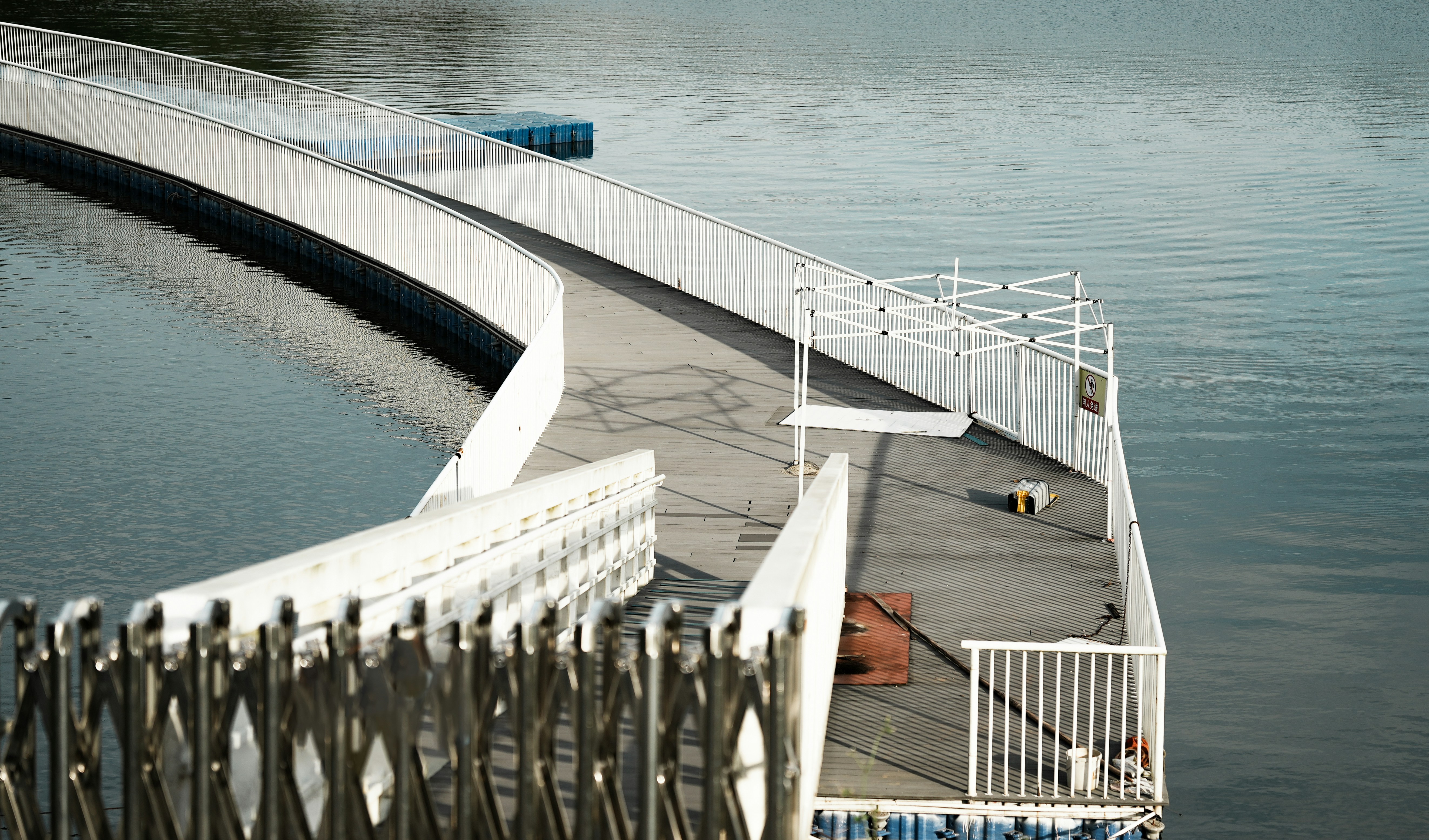 Curved waterfront pier slipping into calm blue water