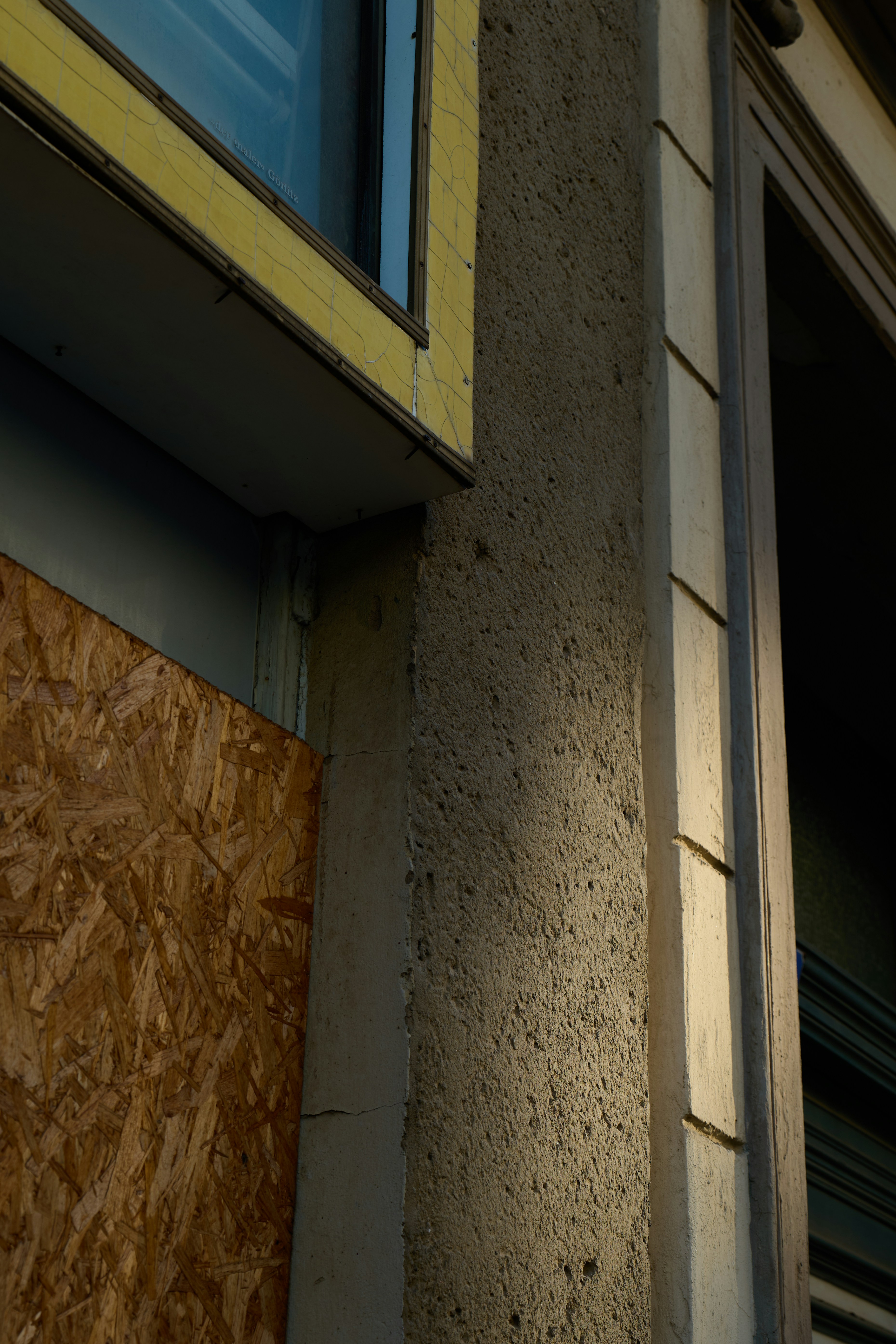 Urban Facade at Dusk: Concrete Texture Meets Steel and Wood