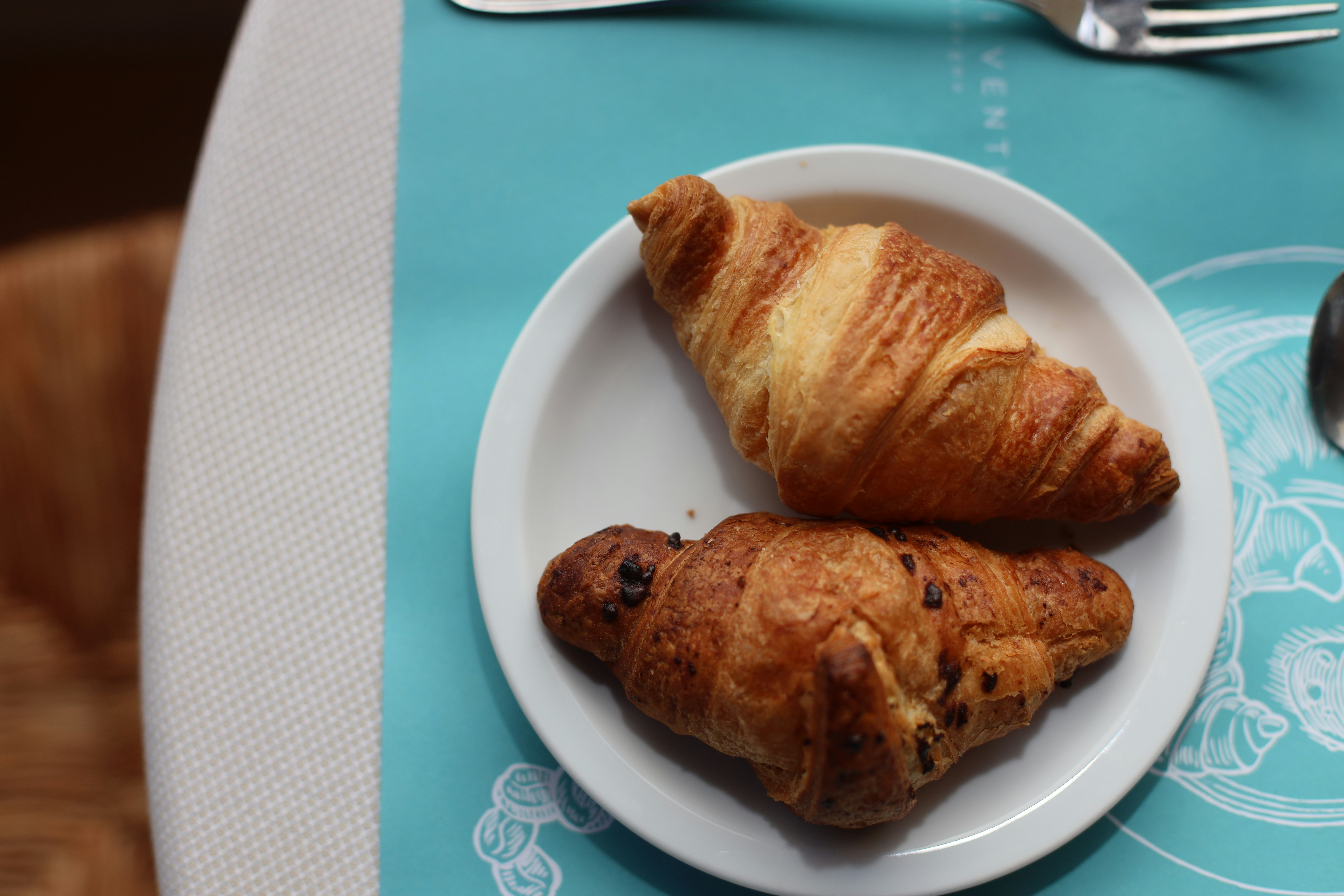 Midday Calm: A Plate of Golden Croissants on a Bright Table