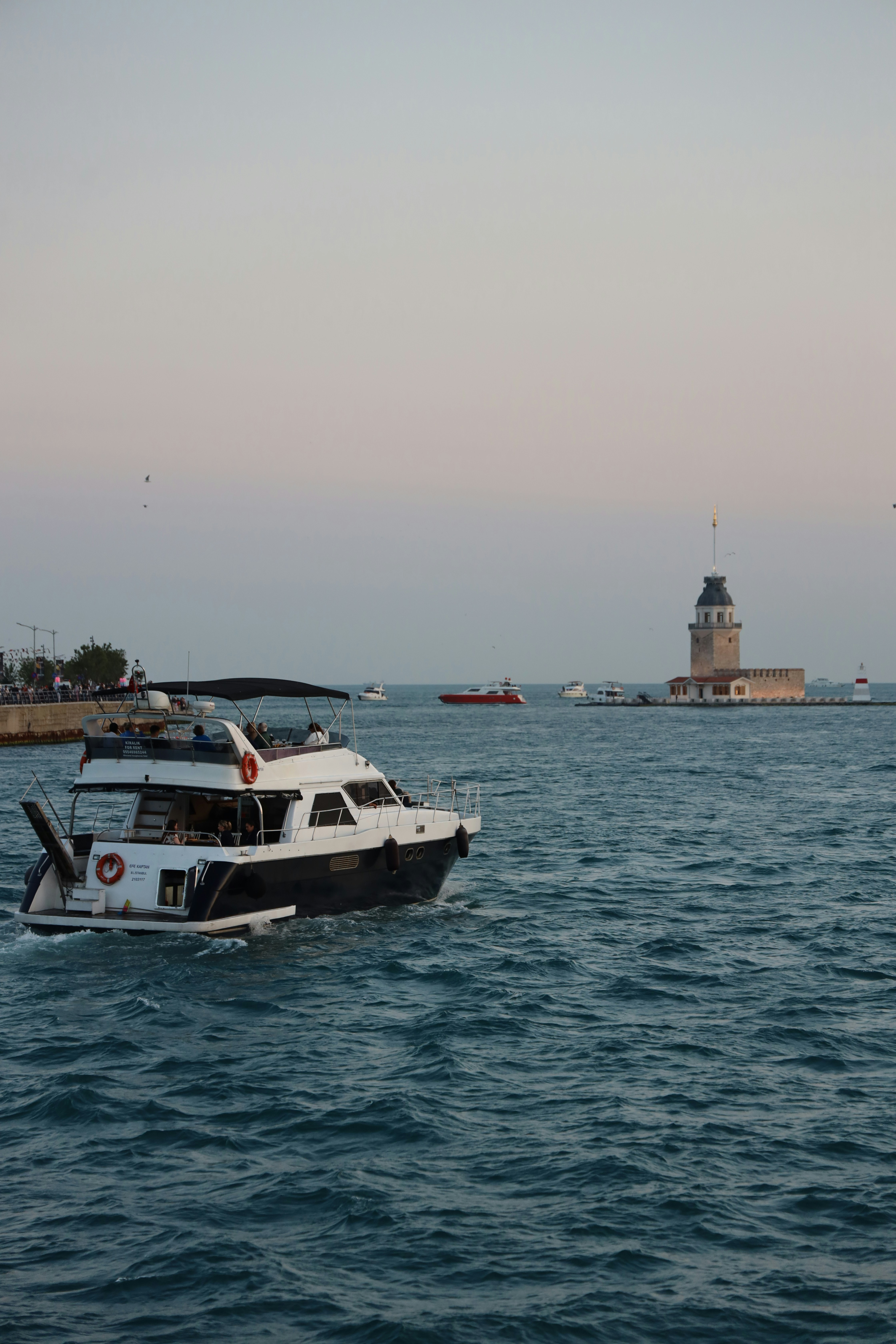 Harbor Vessel at Dusk: A Quiet Convergence of Sea and Lighthouse
