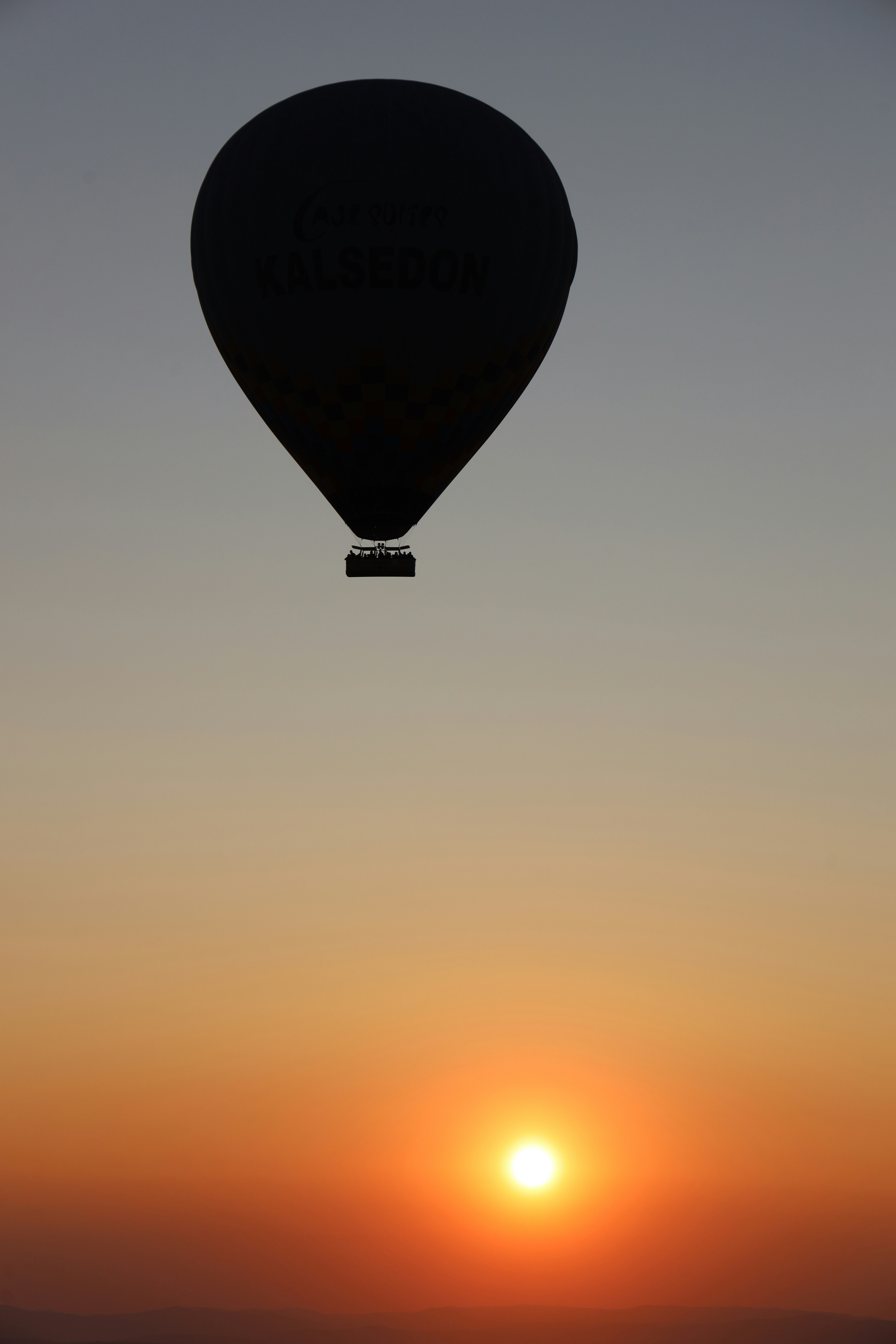 Silhouette Lift: Sunrise Balloon Clears the Horizon