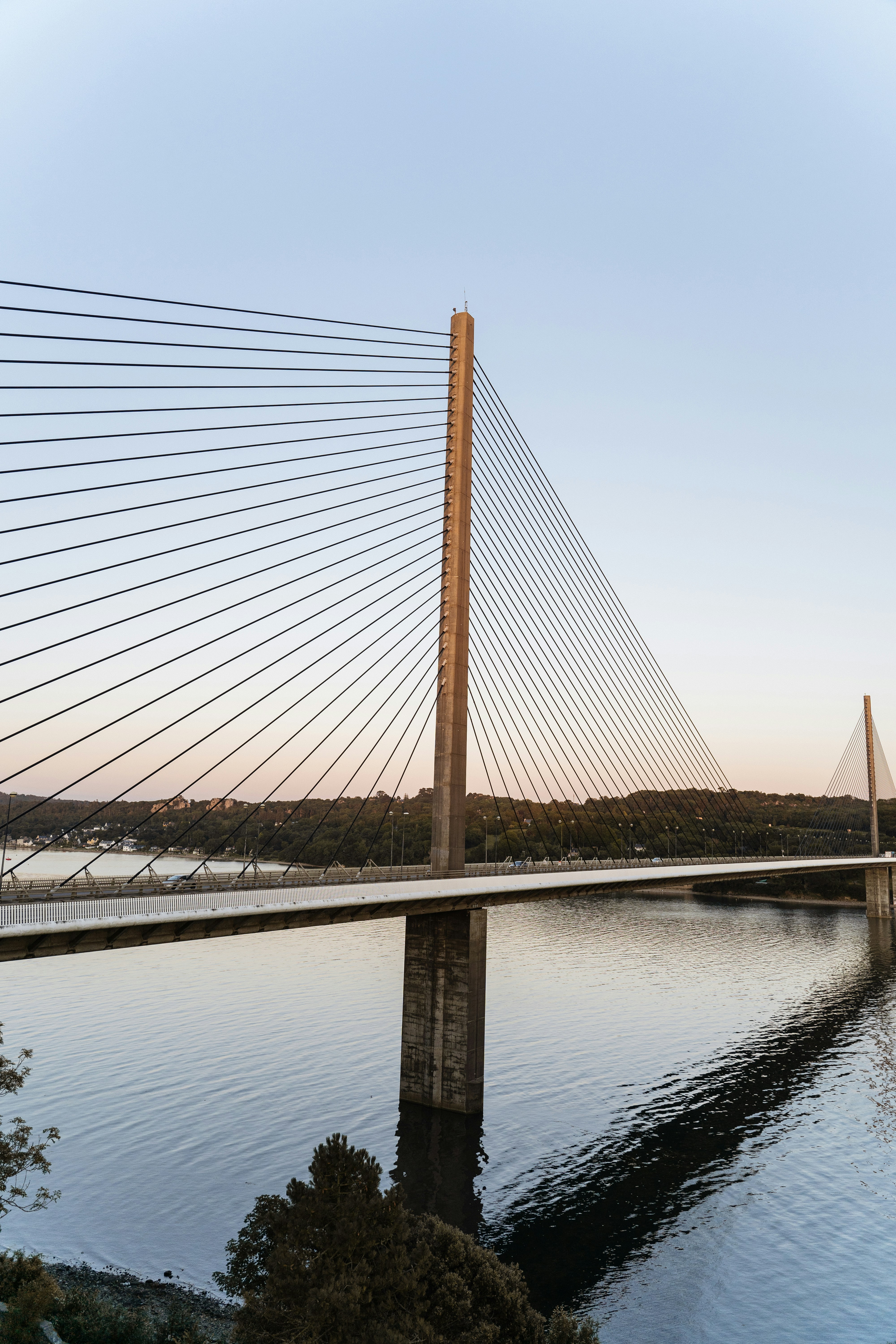 Cable-Stayed Bridge Reaching Across a Quiet River at Dusk