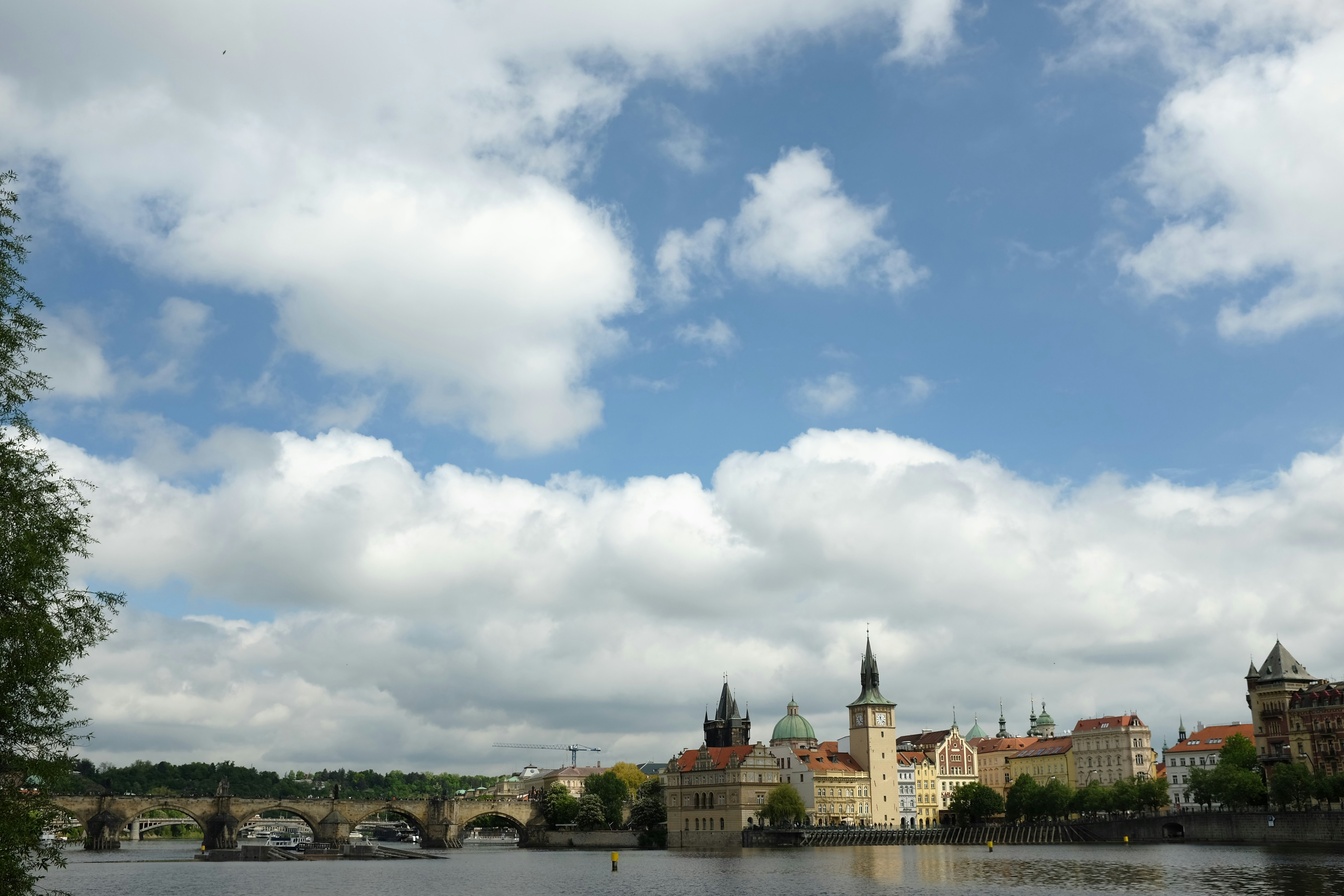 Riverbank Mosaic: A European Cityscape with a Bridge and Domed Roofs