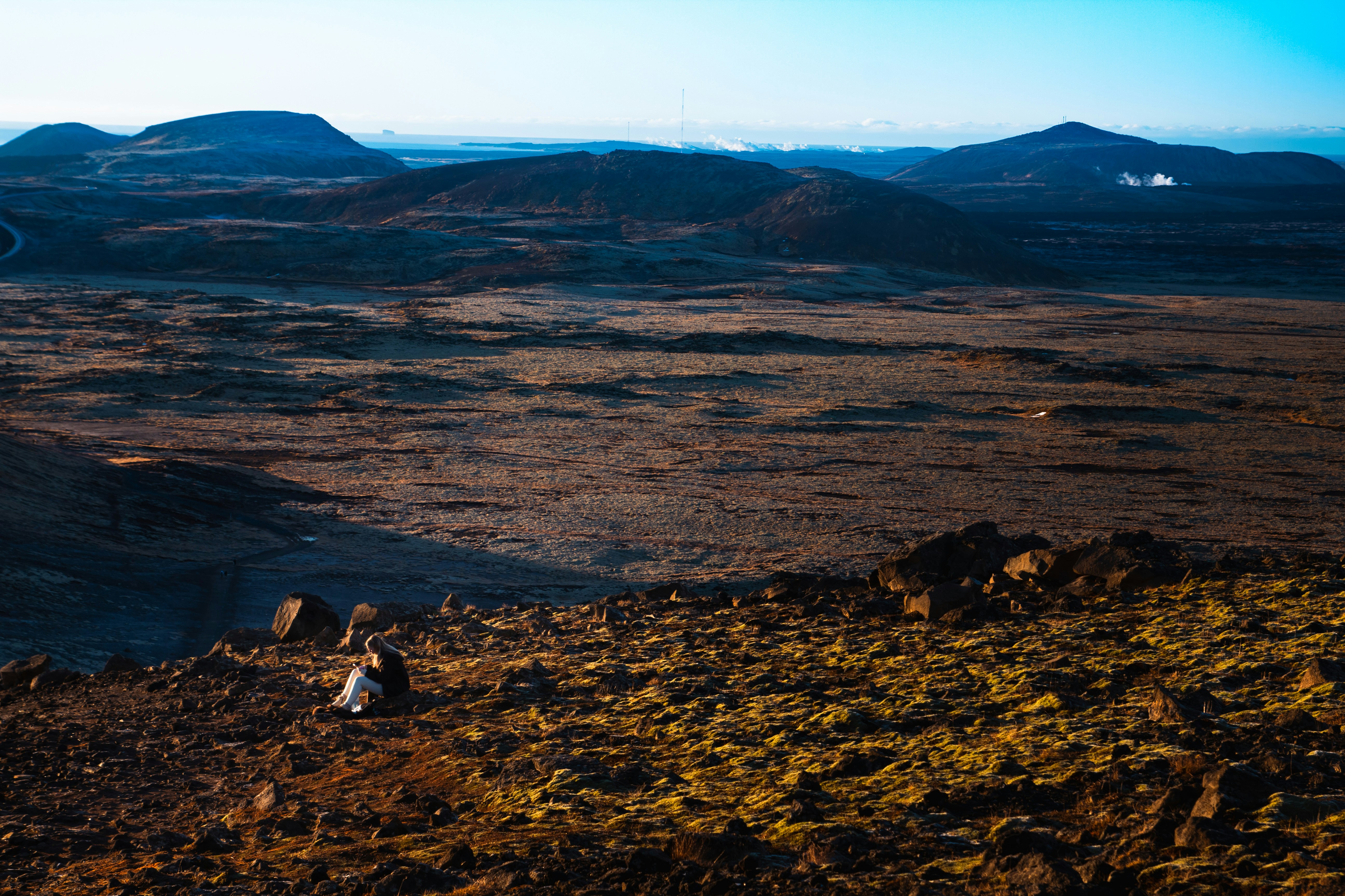 Lava Plain at Dusk: A Lone Visitor Beneath Volcanic Horizons
