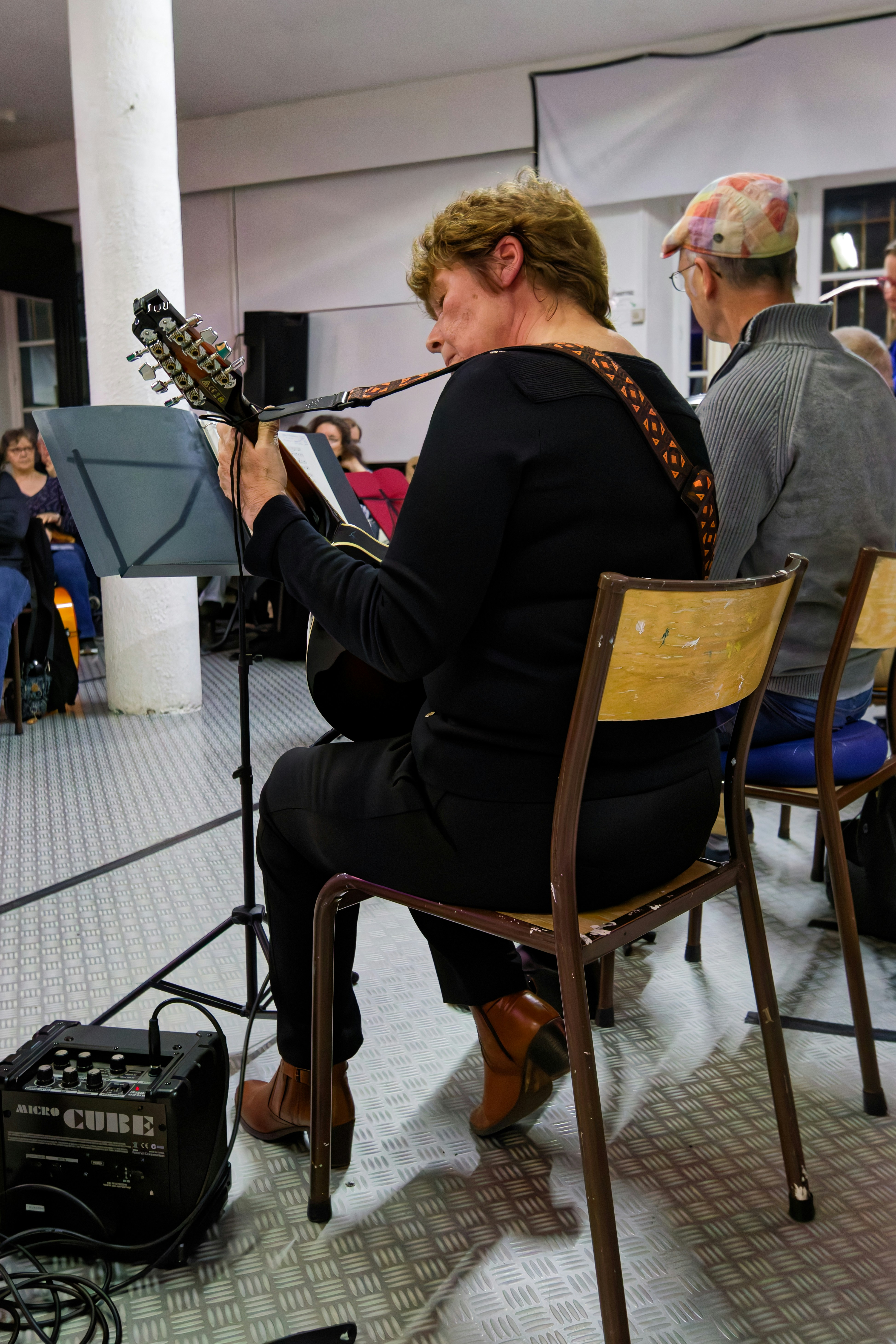 Guitarist in a Quiet Rehearsal: Focus on the Back Row