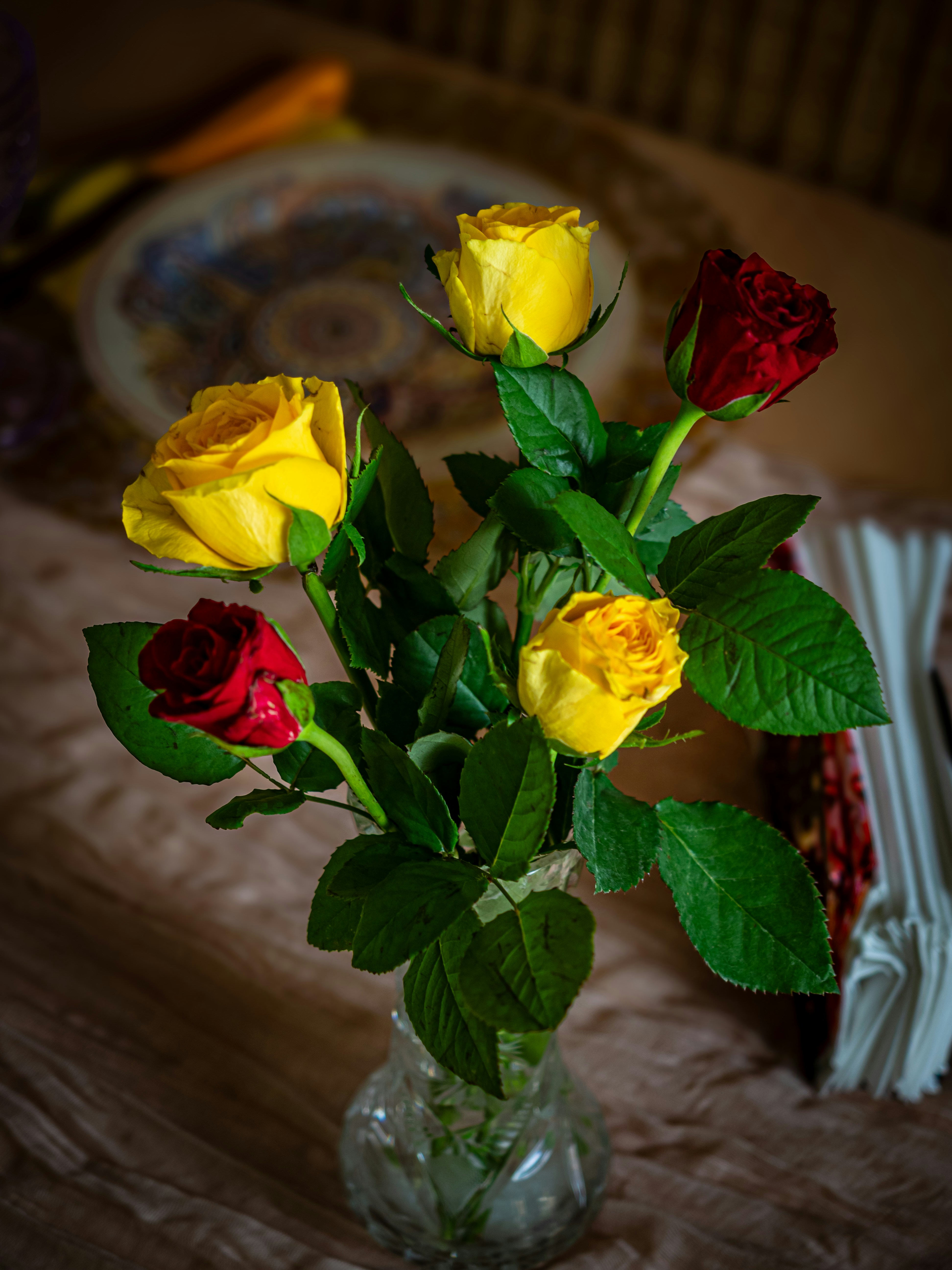Bouquet of Dual Colors: Yellow and Red Roses in Glass Vase