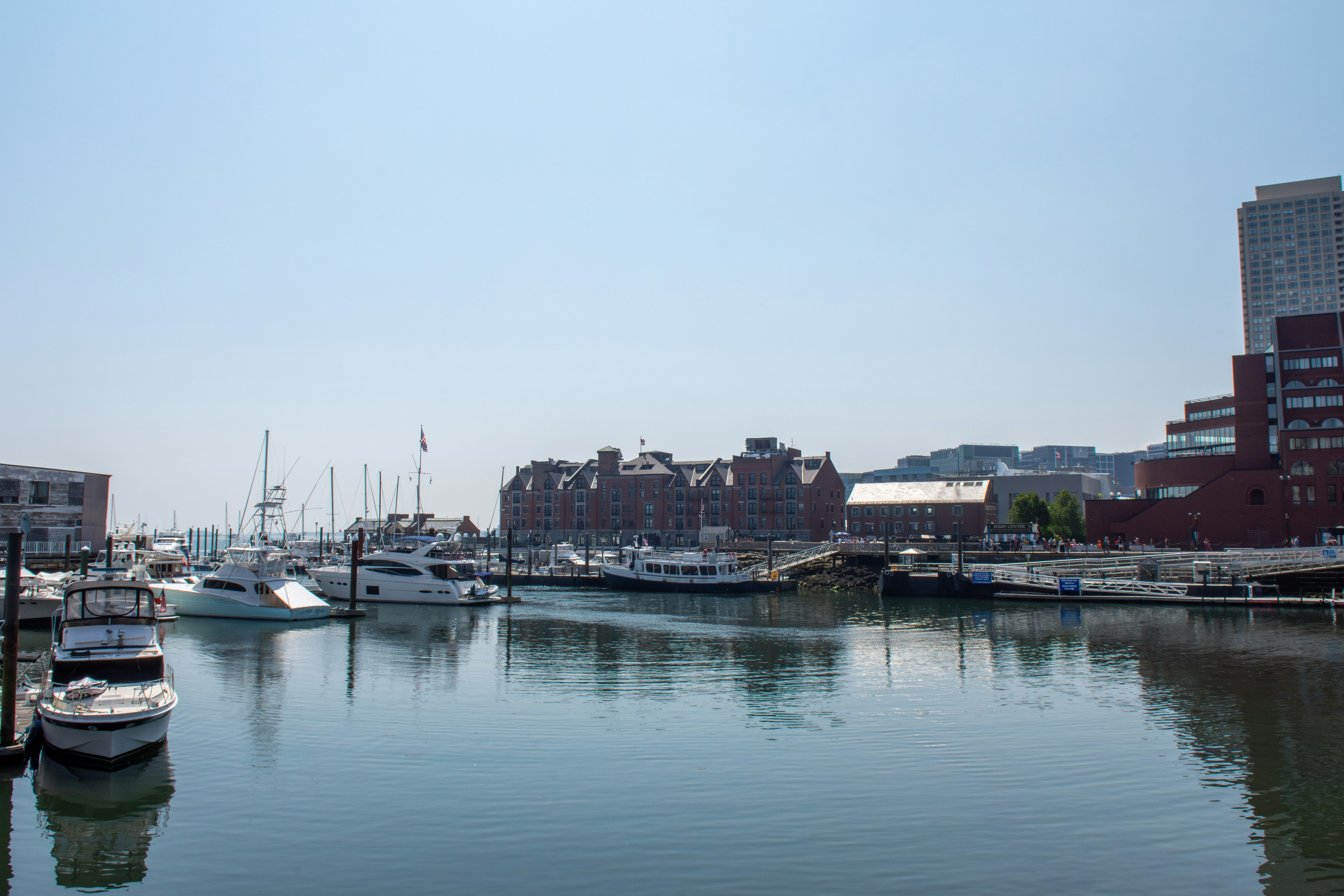 Harbor Reflections at Dusk: Boats and Brick Skyline