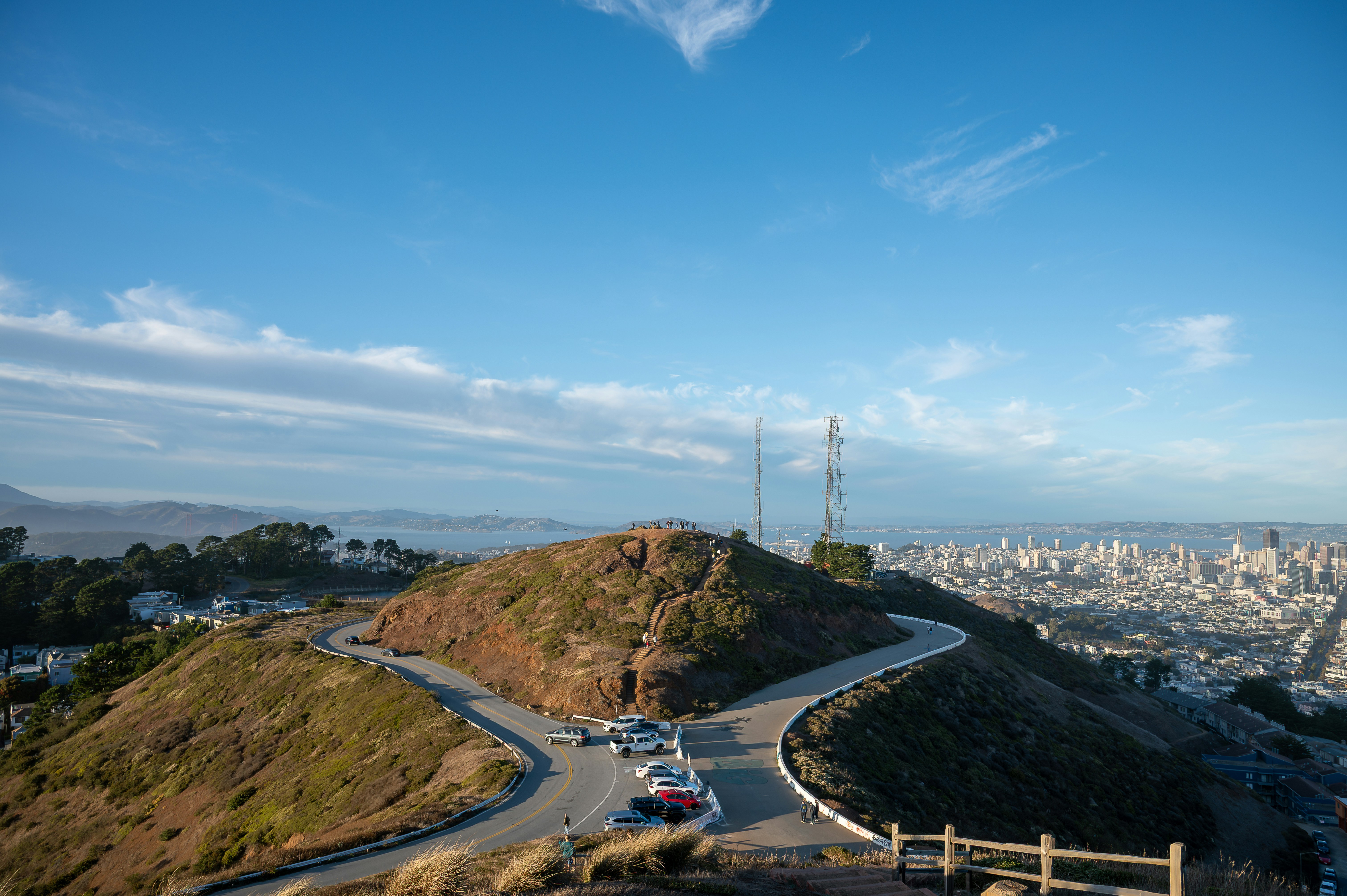 Ridge Road Overlook: The winding path to the hilltop with cityscape beyond