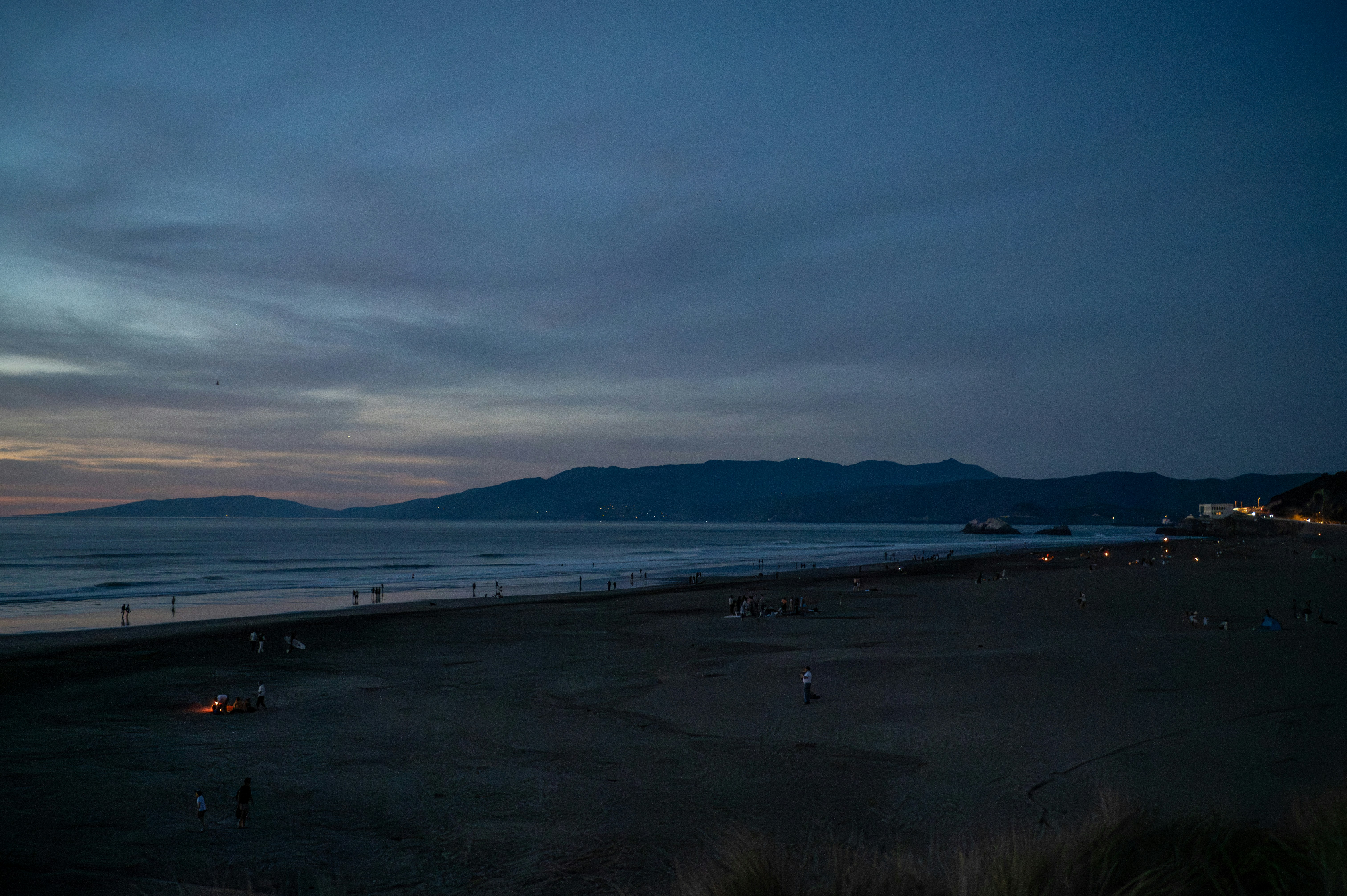 Twilight Beachline: Distant Lights and Quiet Shore