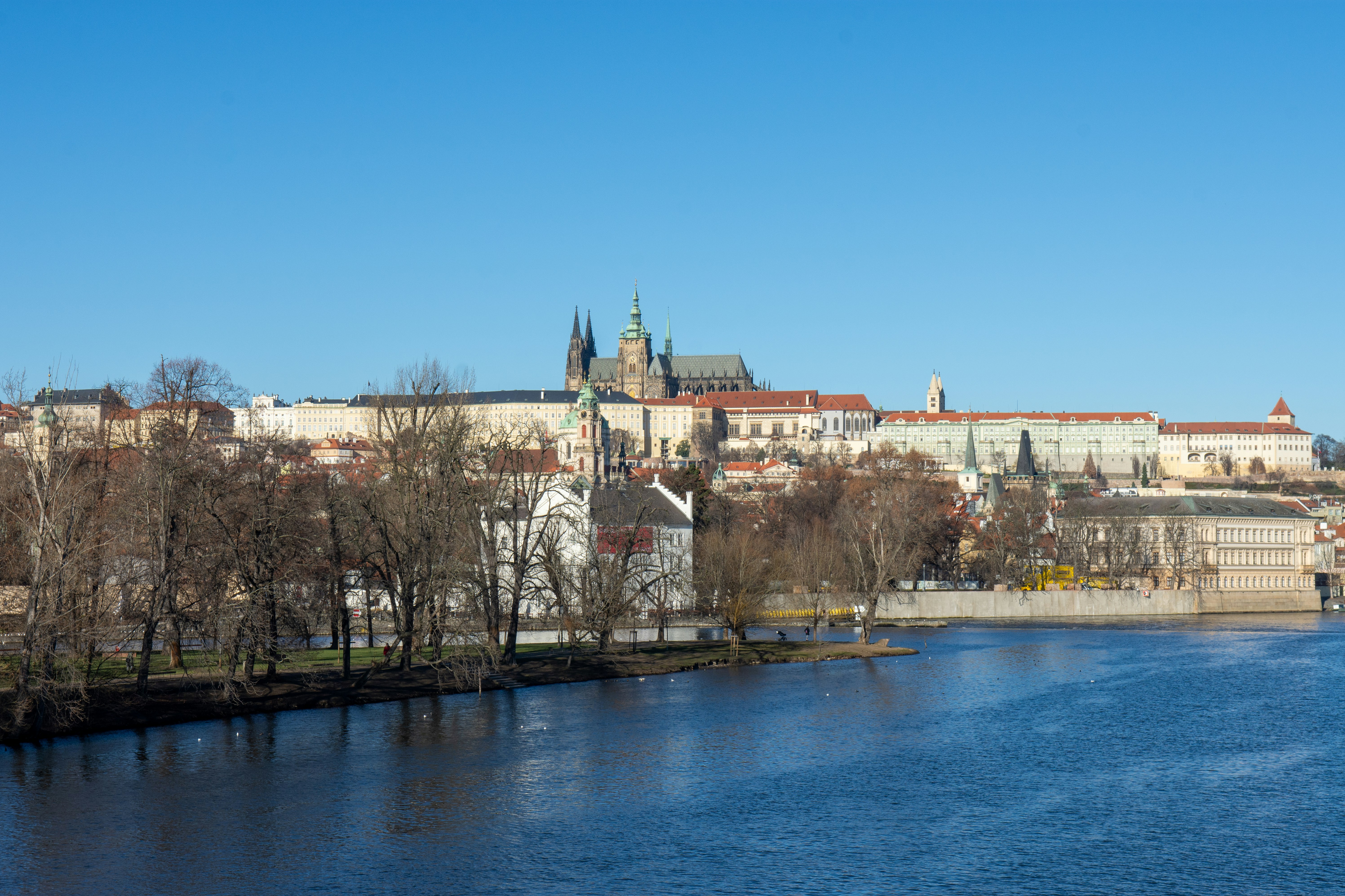 Riverside Citadel: Cityscape with Upland Roofs under a Clear Sky