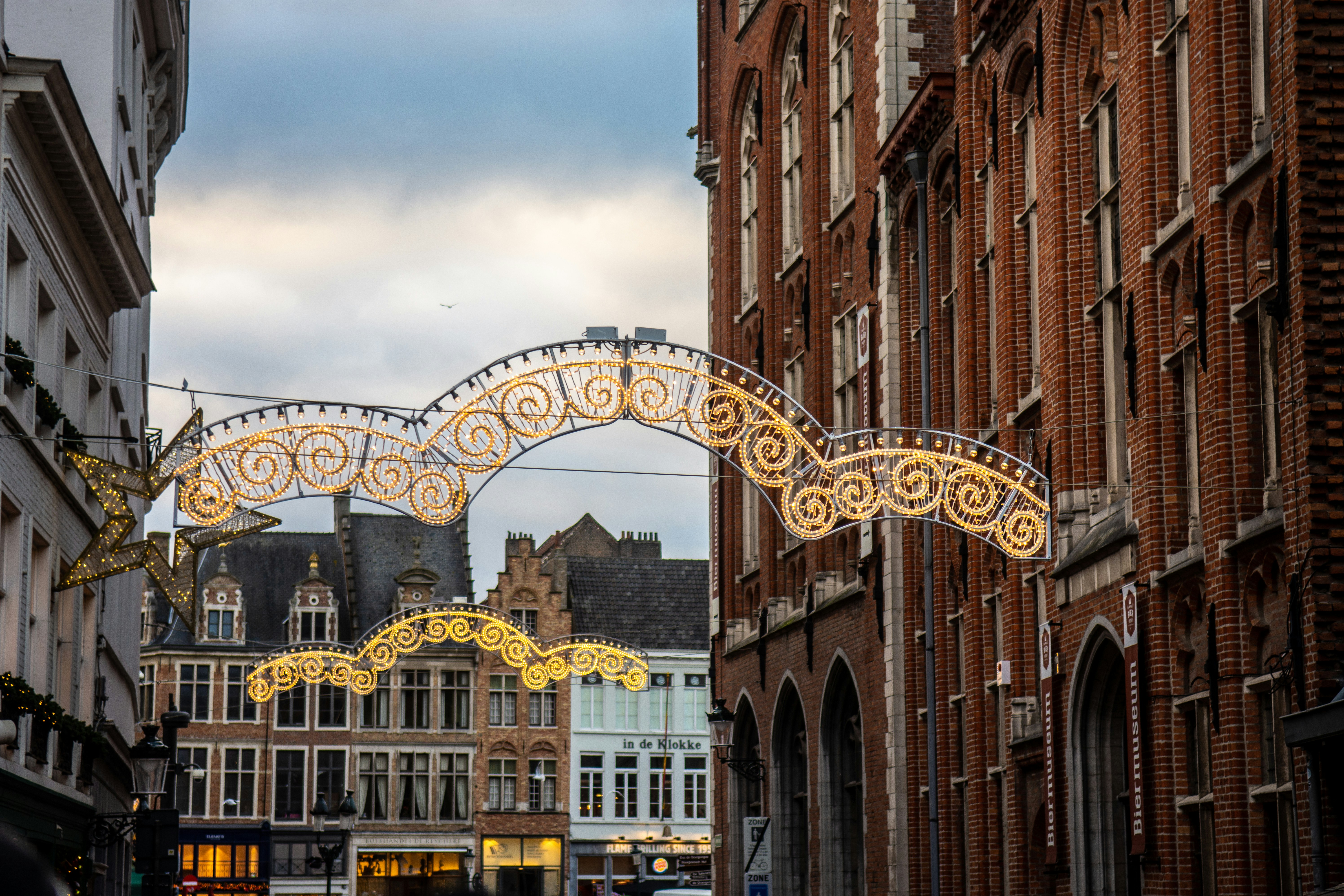 Festive Neon Arches Over a Historic Dutch Street