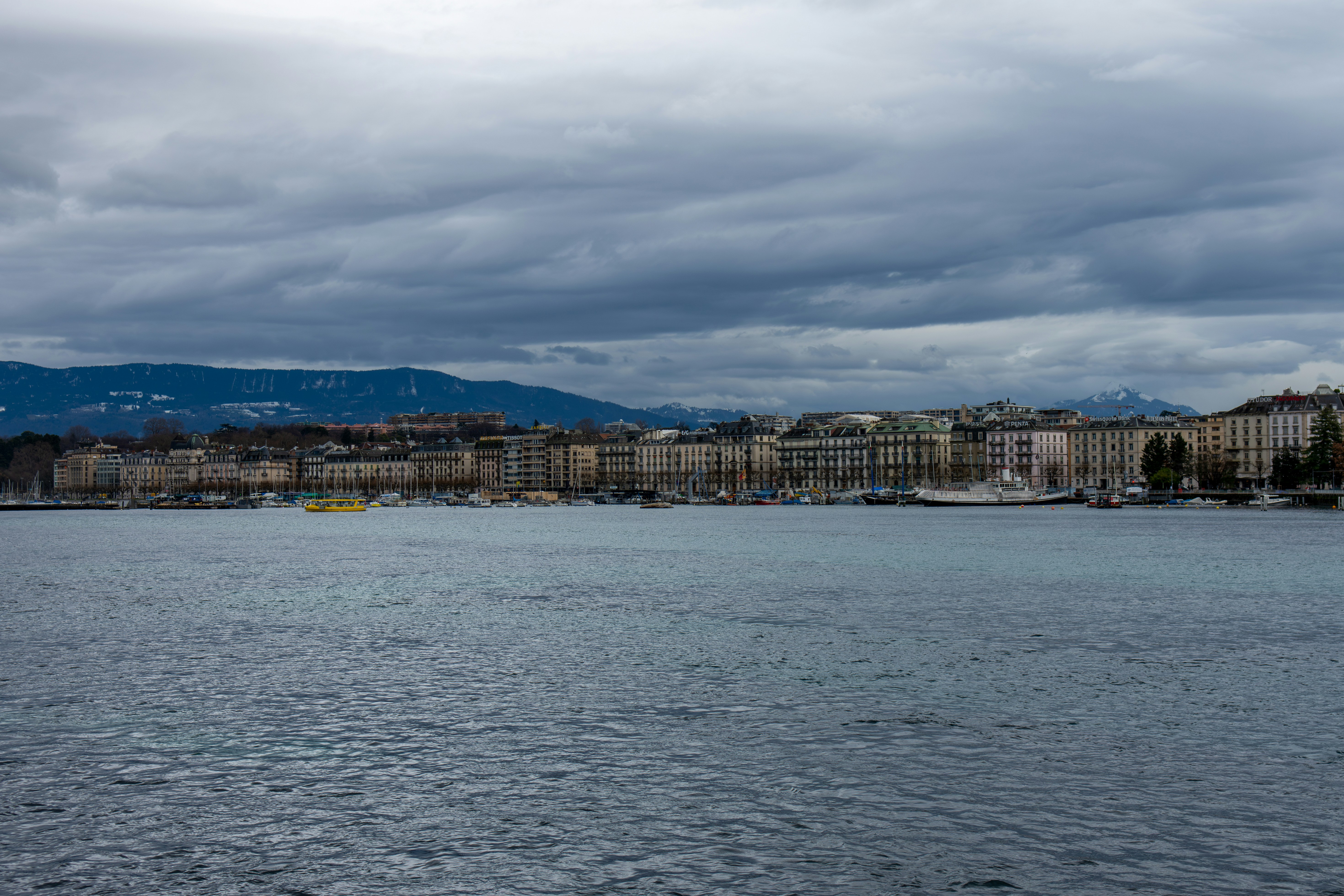 City by the Lake: Calm Waters Under Brooding Skies