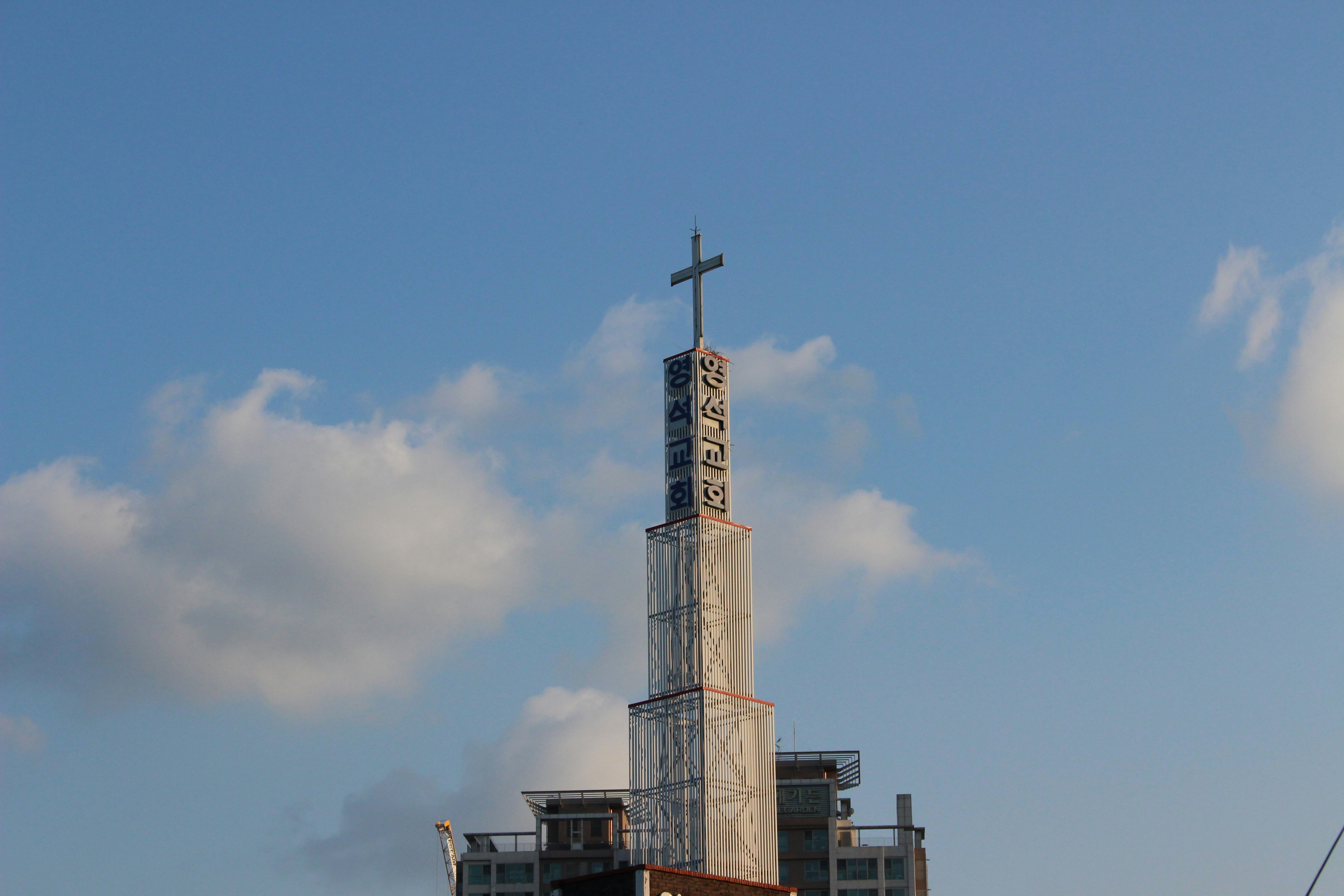Towering Cross on Sky-Blue Crest