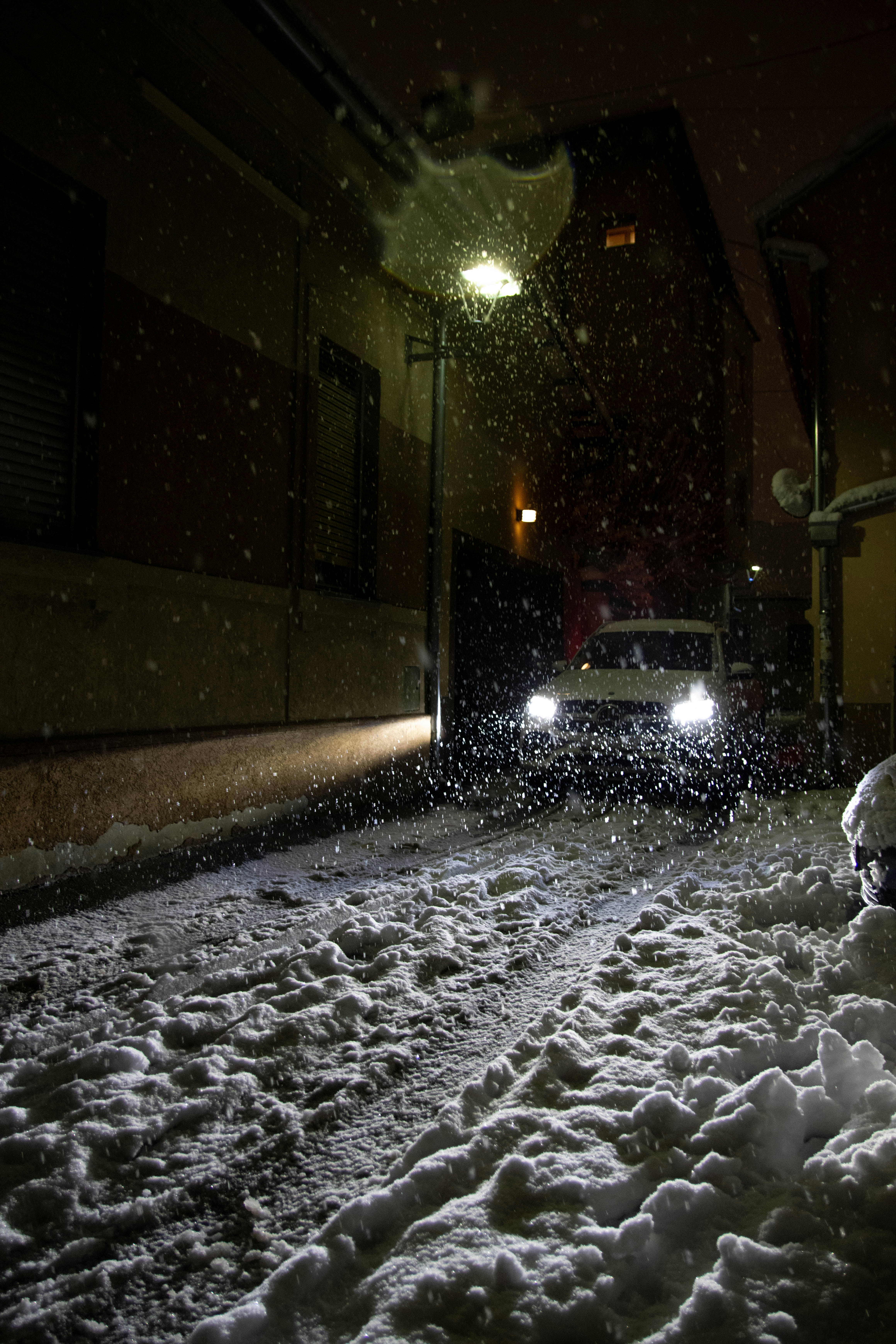 Snowy Street Standoff: Headlights Cutting Through the Night