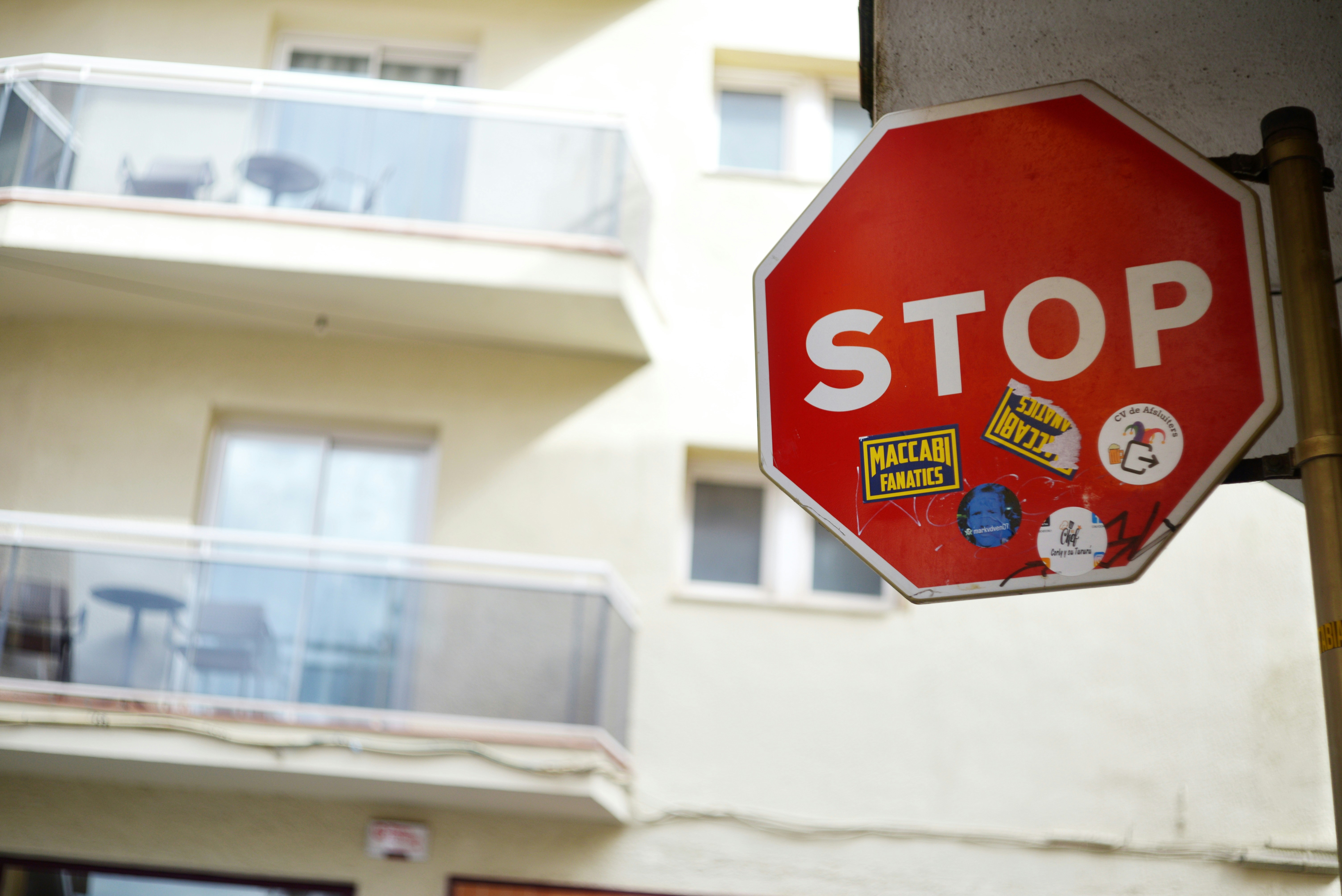 Urban Stop Sign with Stickered Vigilance
