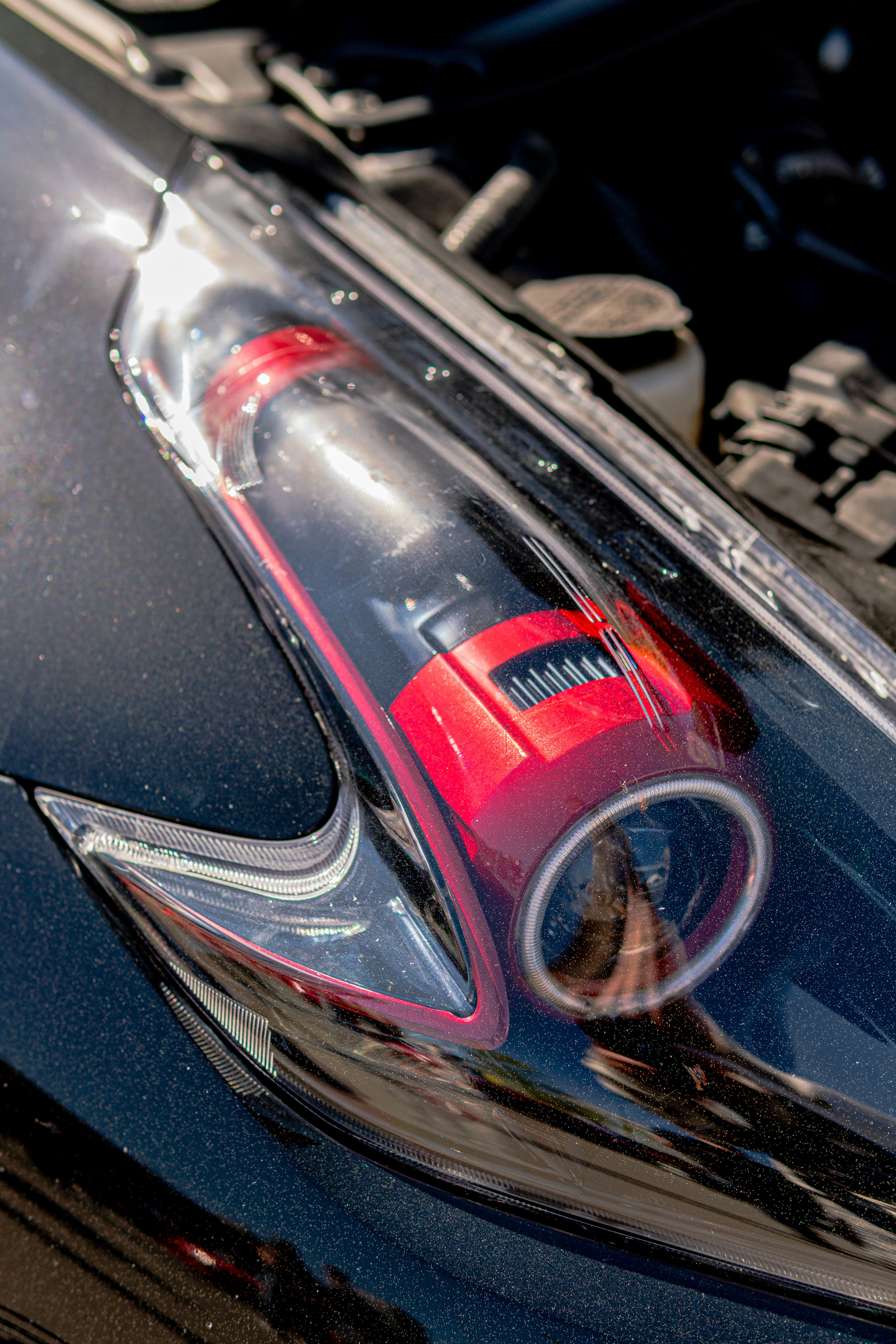Crimson Circular Accent: a close-up on the car's headlamp edge