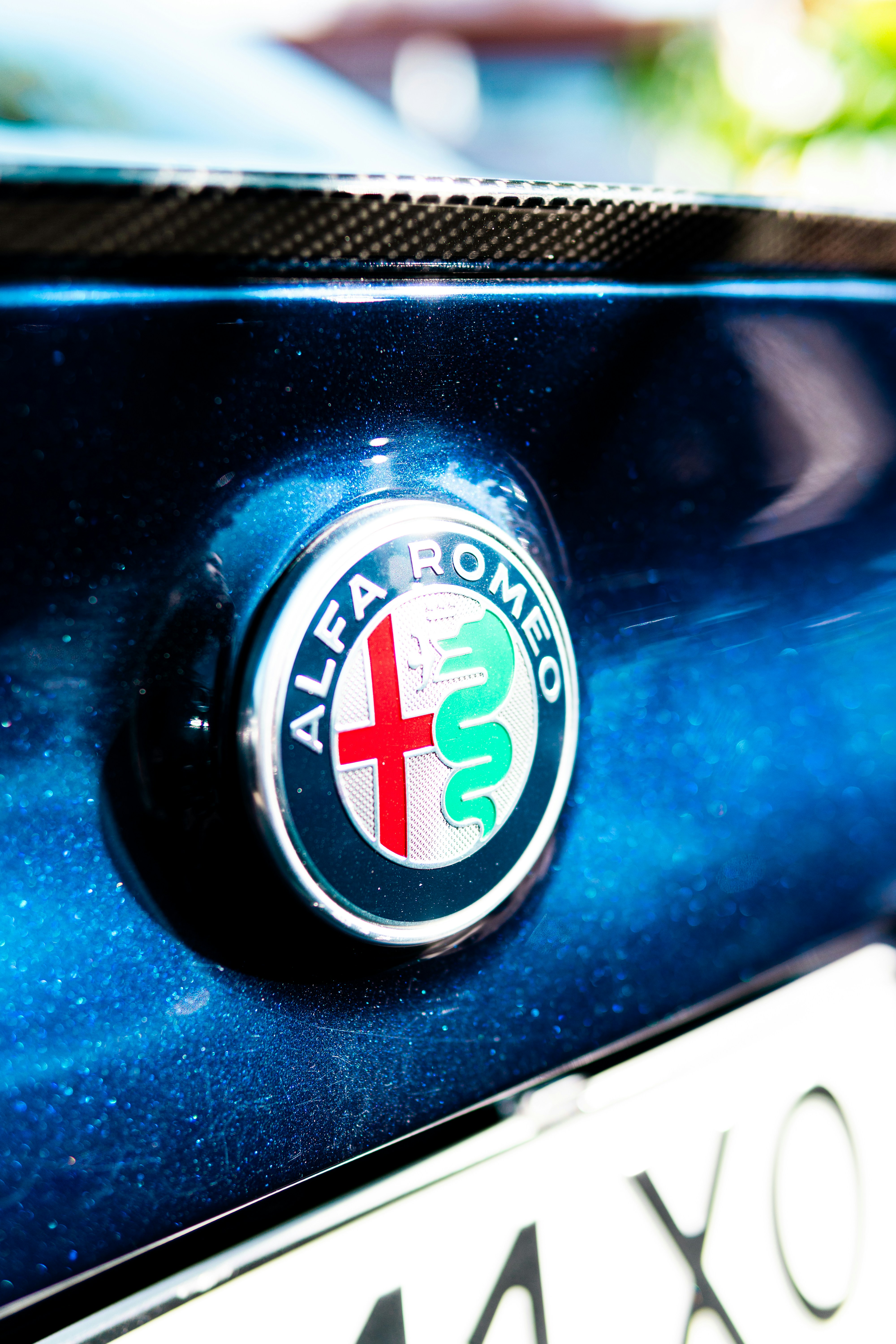 Emblem in Focus: Alfa Romeo Badge Fringed by Metallic Blue Curves