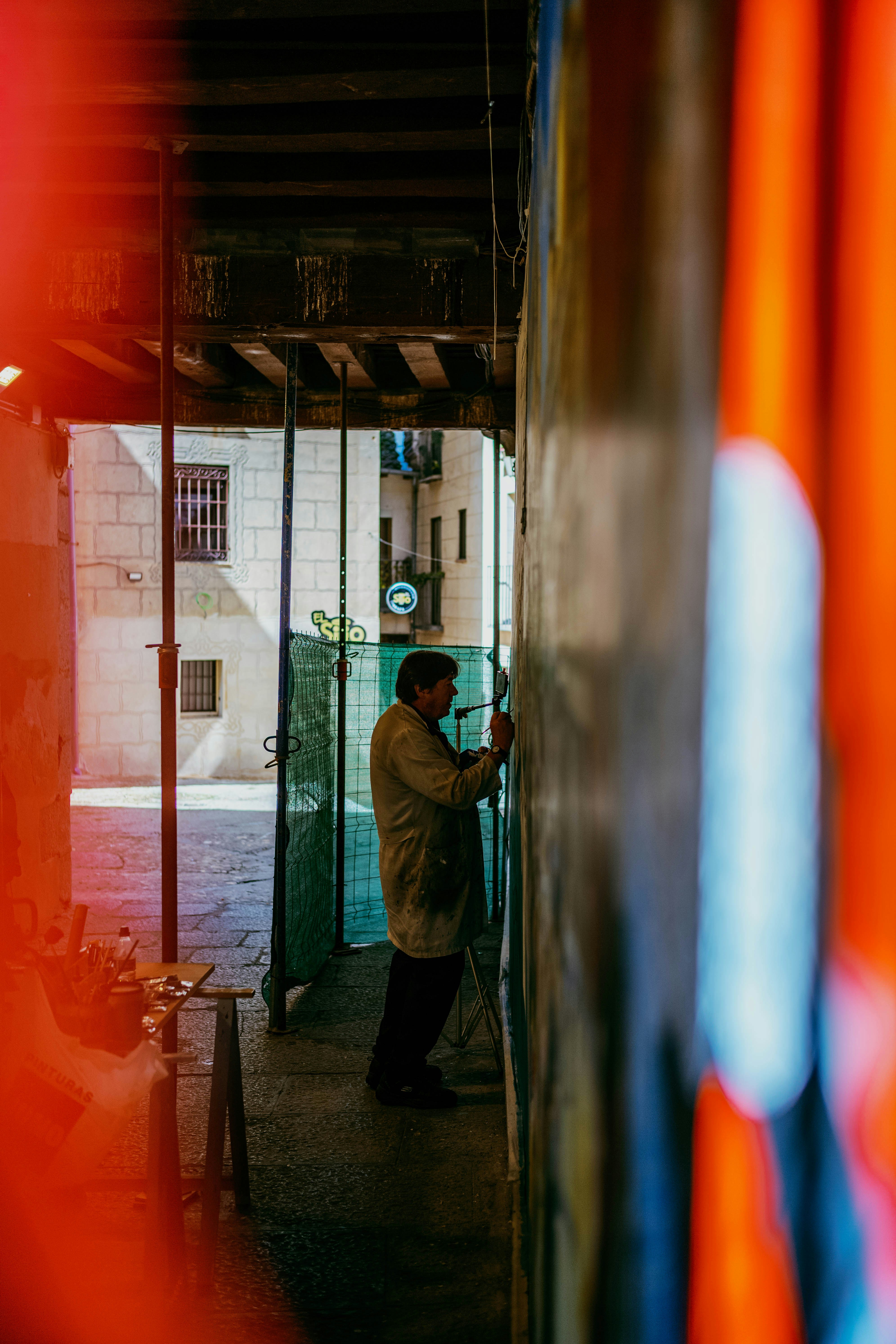 Between the Gates: A Silhouette in the Back Alley of Color