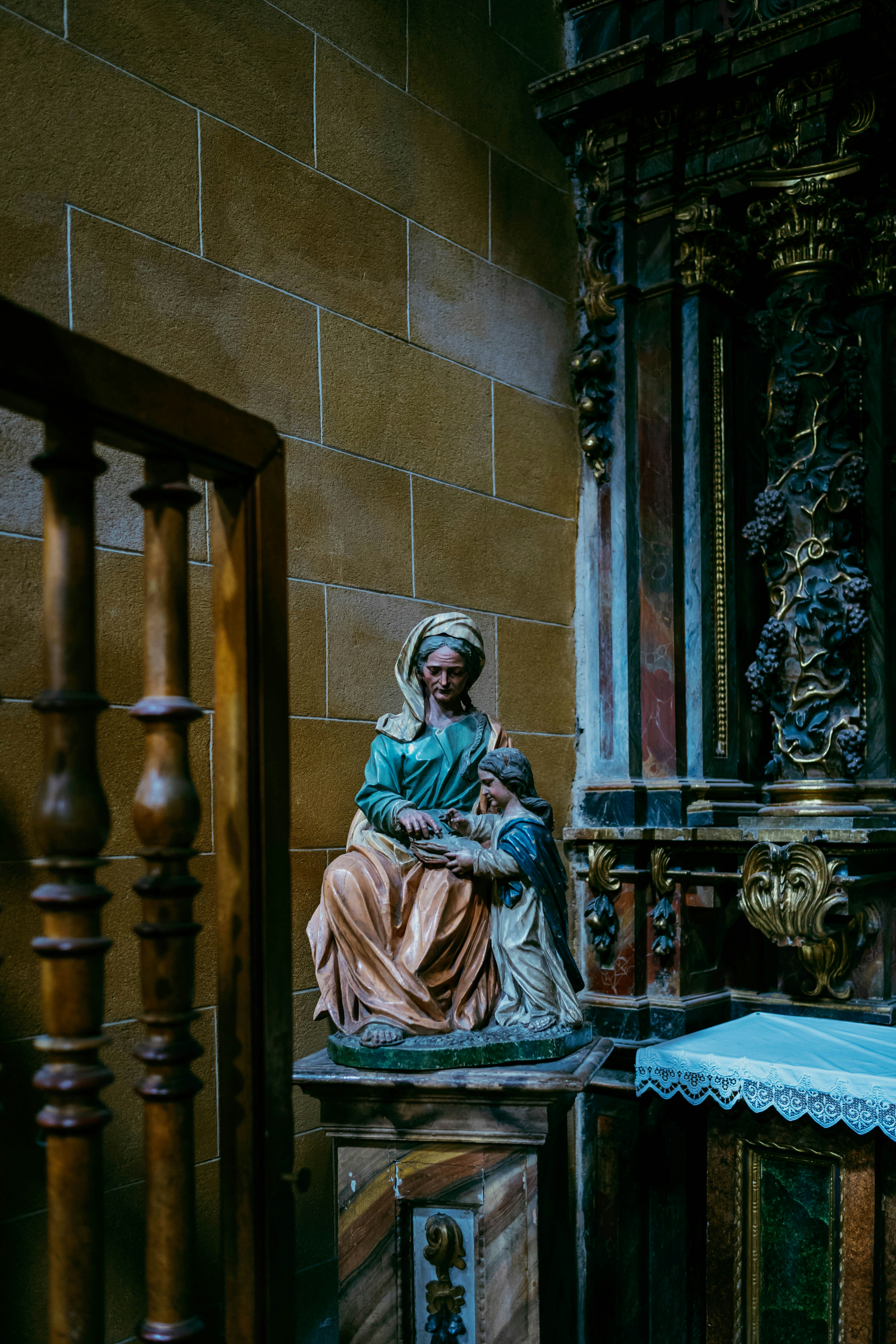 Statue of Mother and Child Silhouetted by Ornate Altarpiece