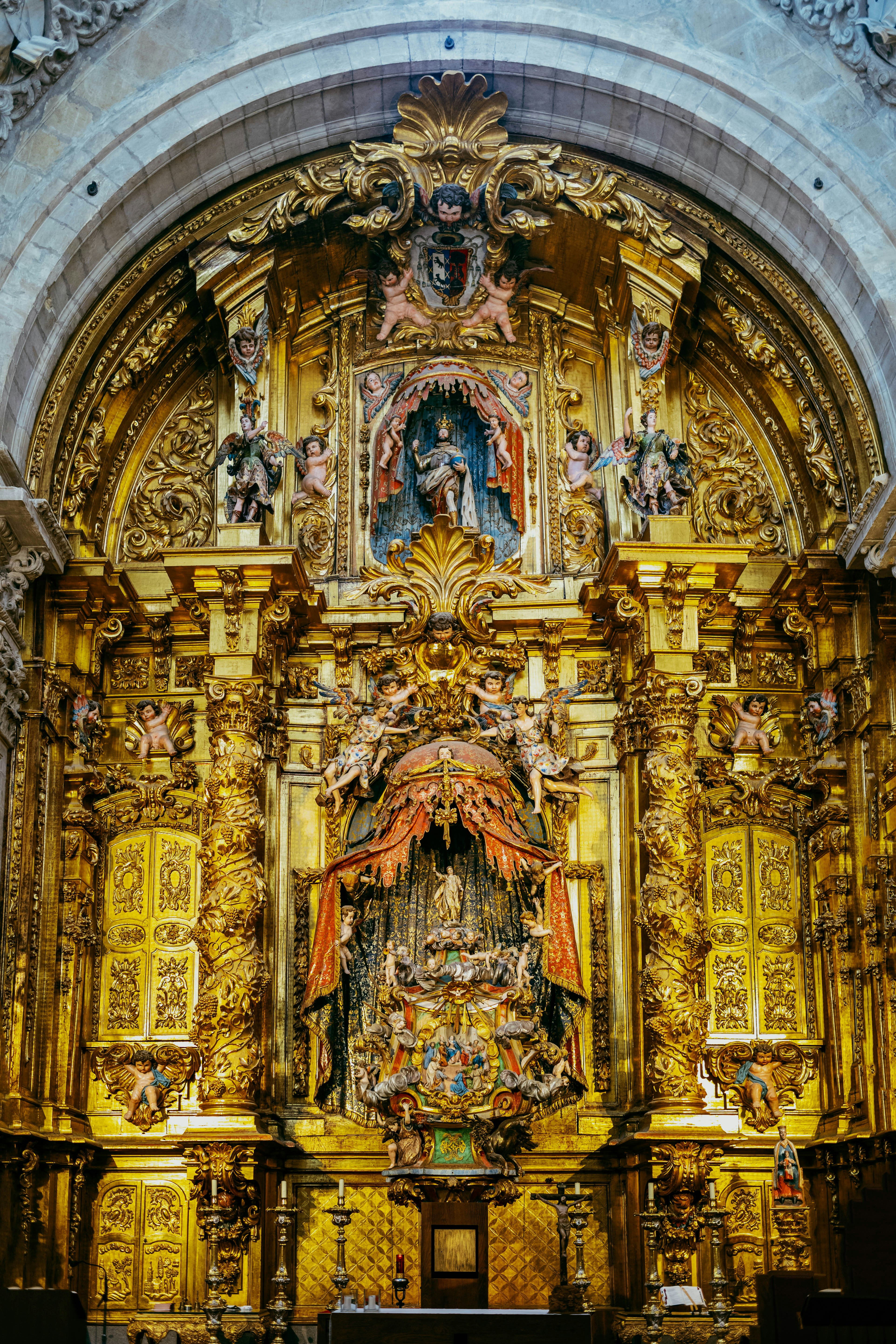 Golden Altarpiece: Baroque Splendor Amid Statuary and Reliefs