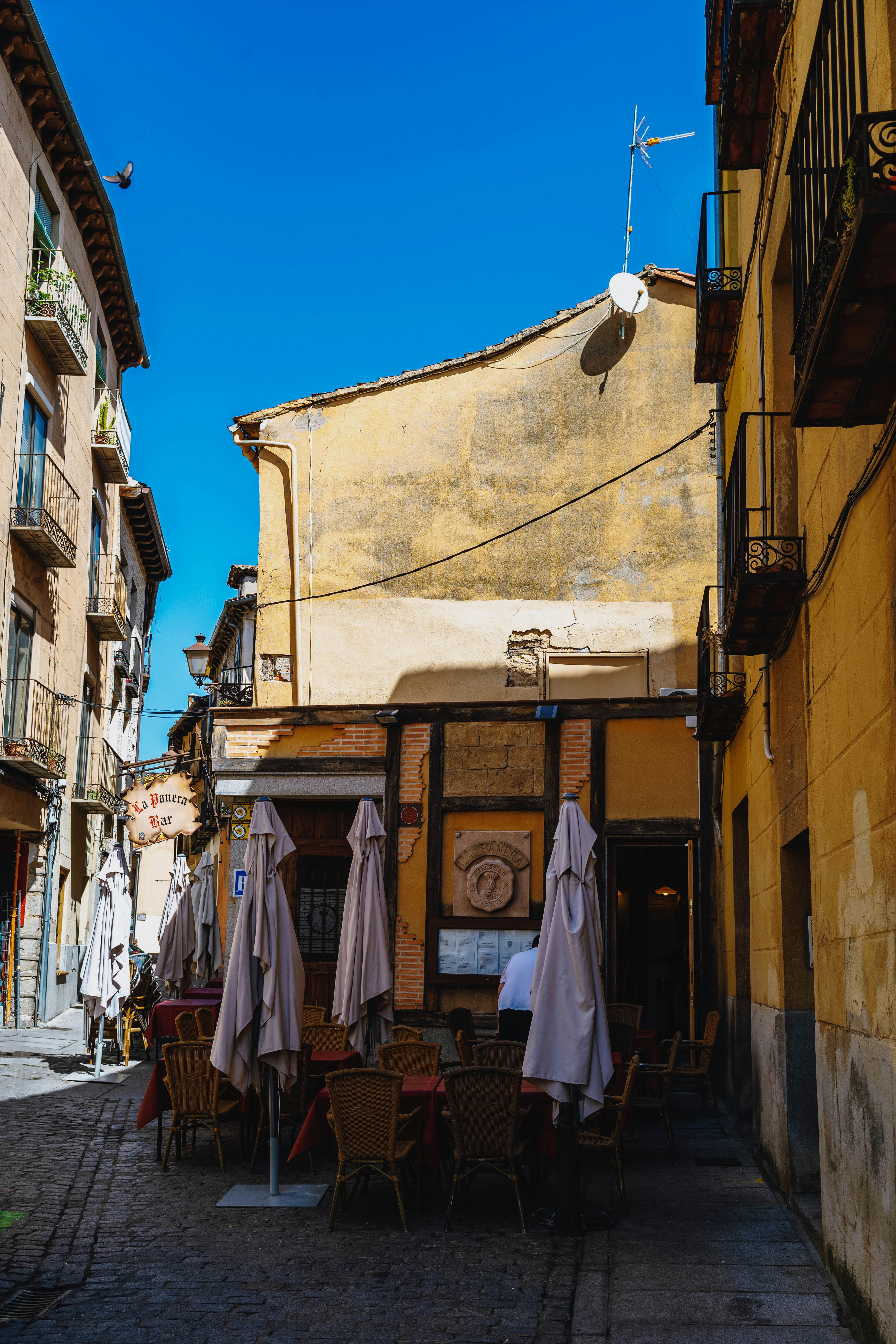 Cobbled Courtyard Café Under A Bright Blue Sky