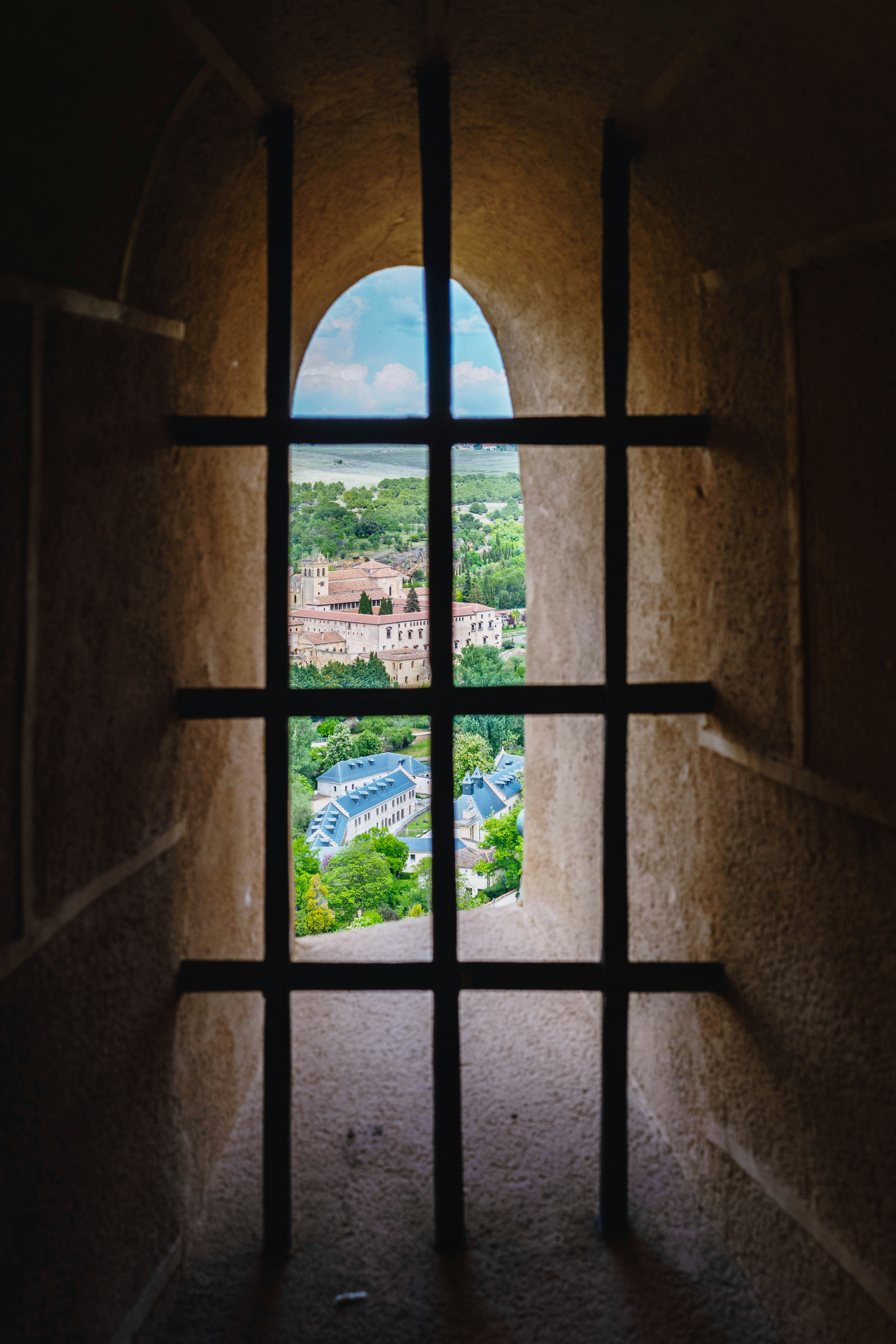 Through the Iron Wake: Courtyard View Beyond the Window Bars