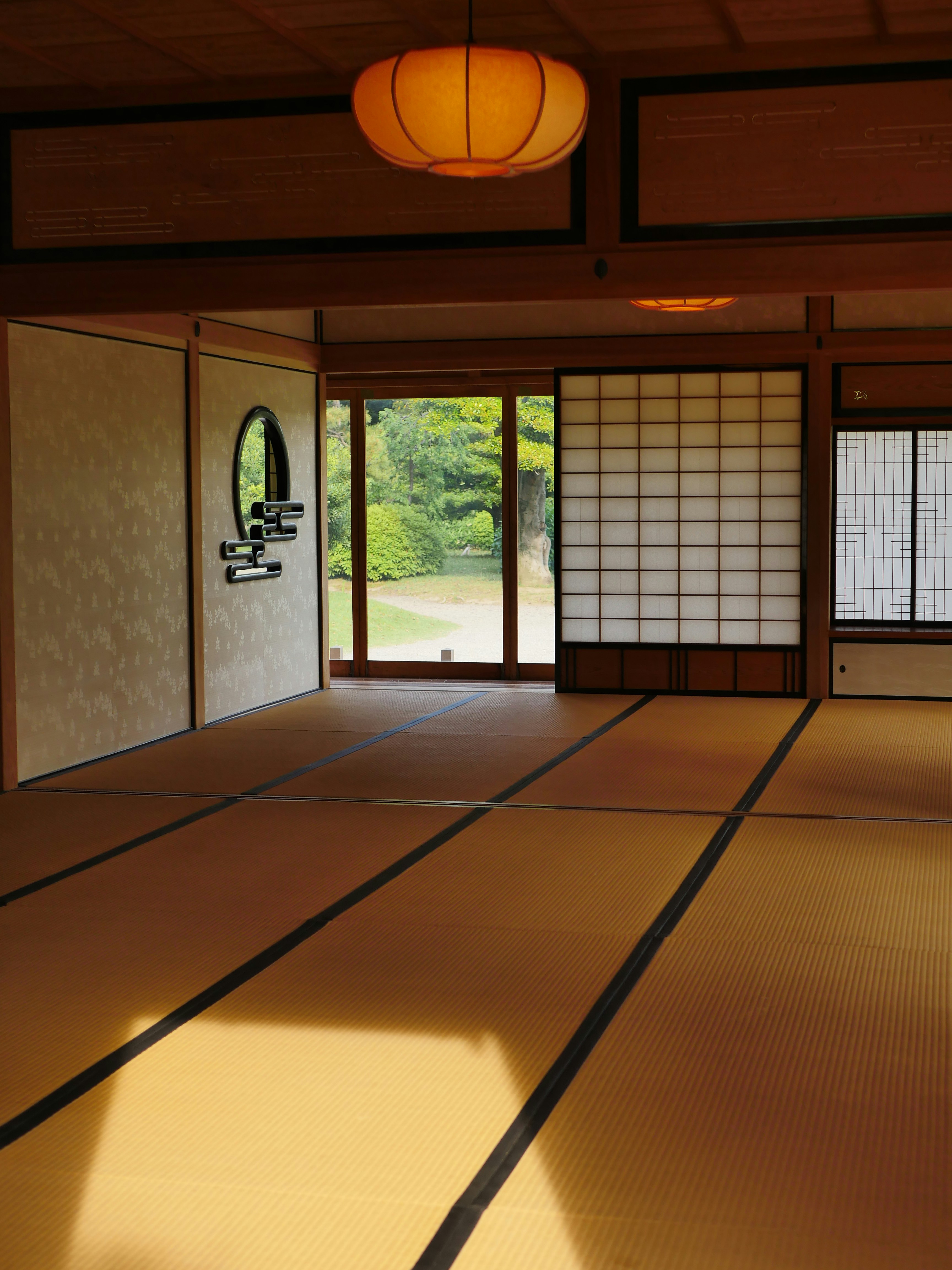 Sunlit Japanese Engineered Calm: An Empty Tatami Room Opening to a Garden