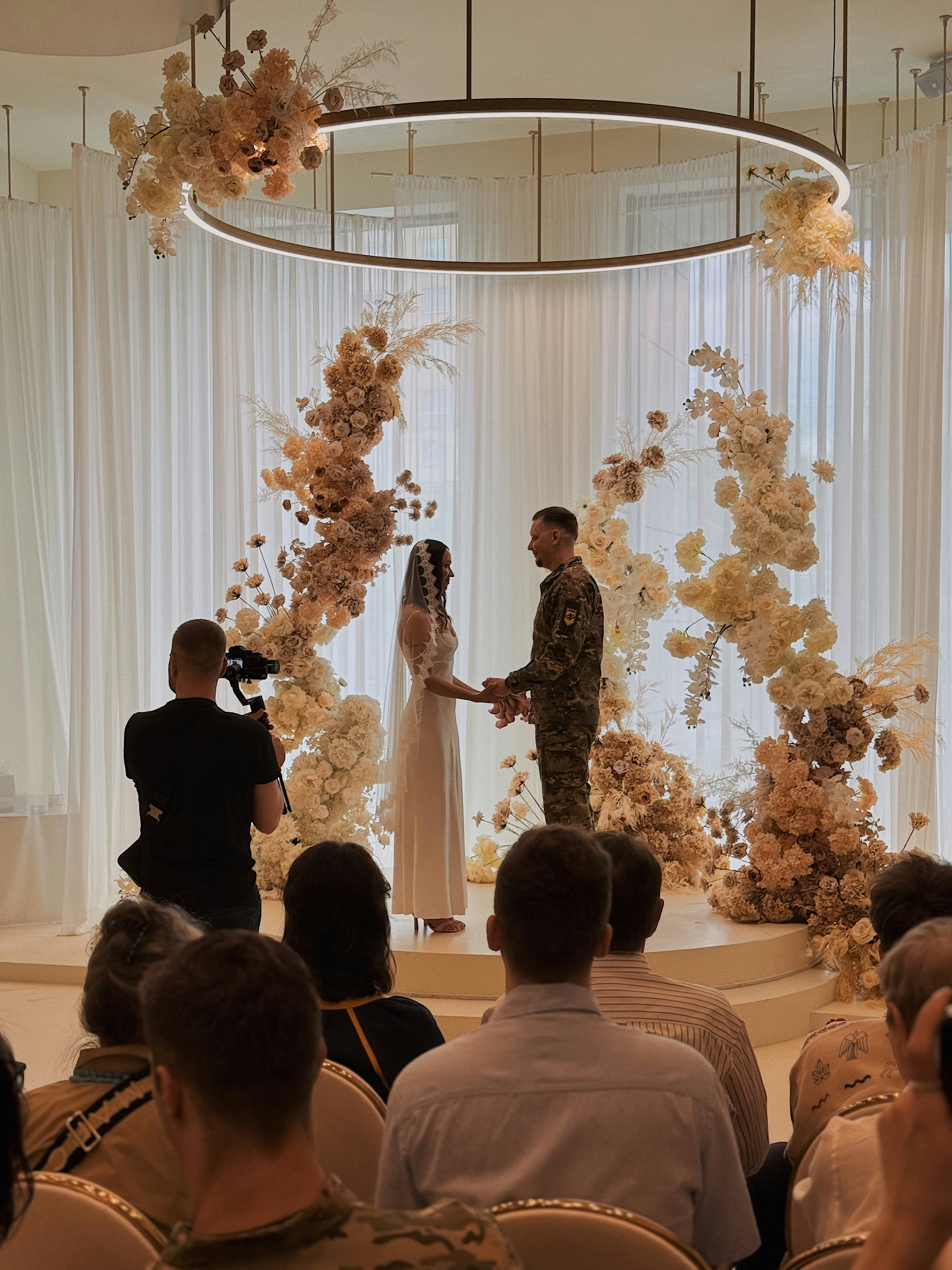 Wedding vows under a halo of floral arches