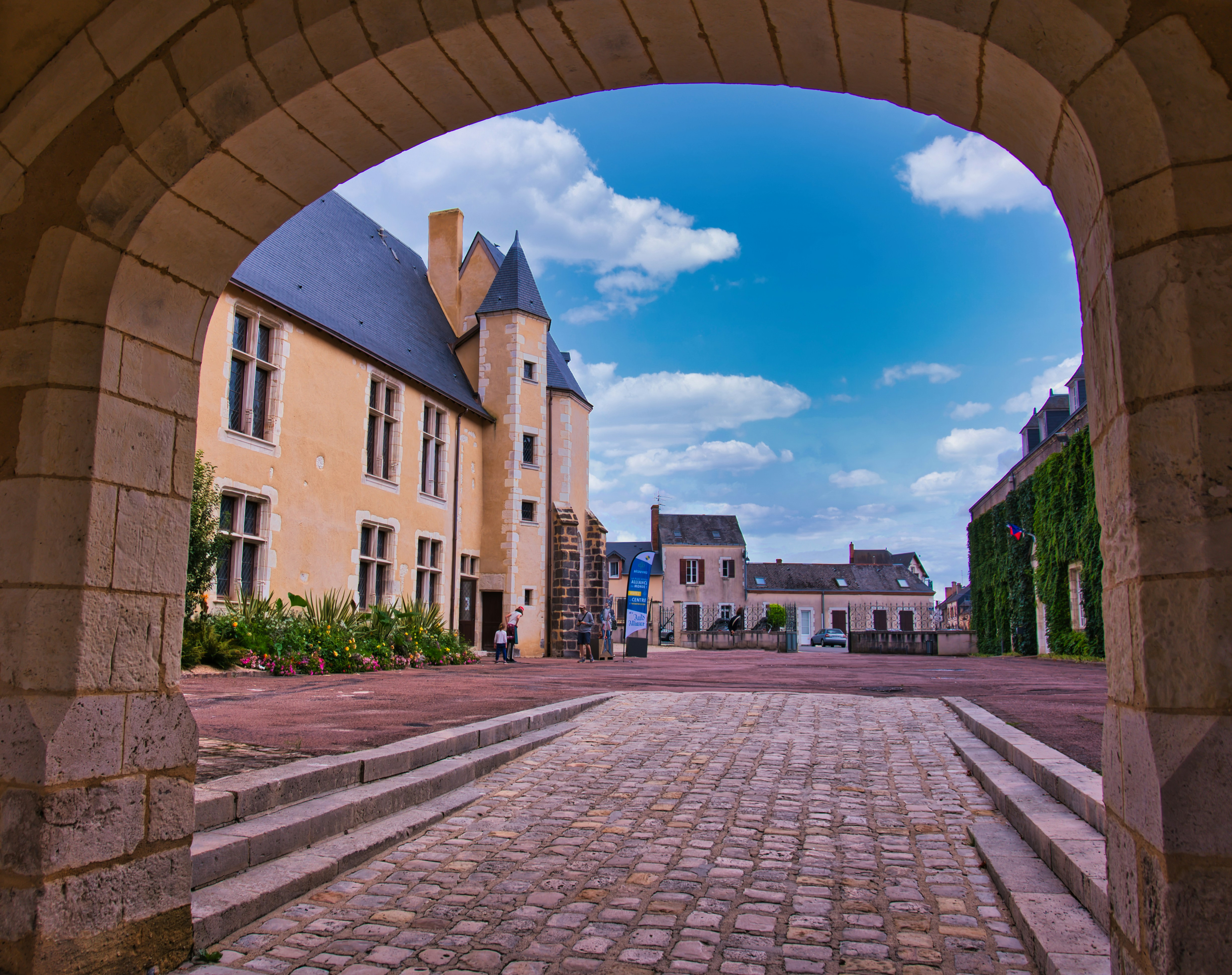Archway to the Courtyard: Cobblestones and Collegiate Turrets