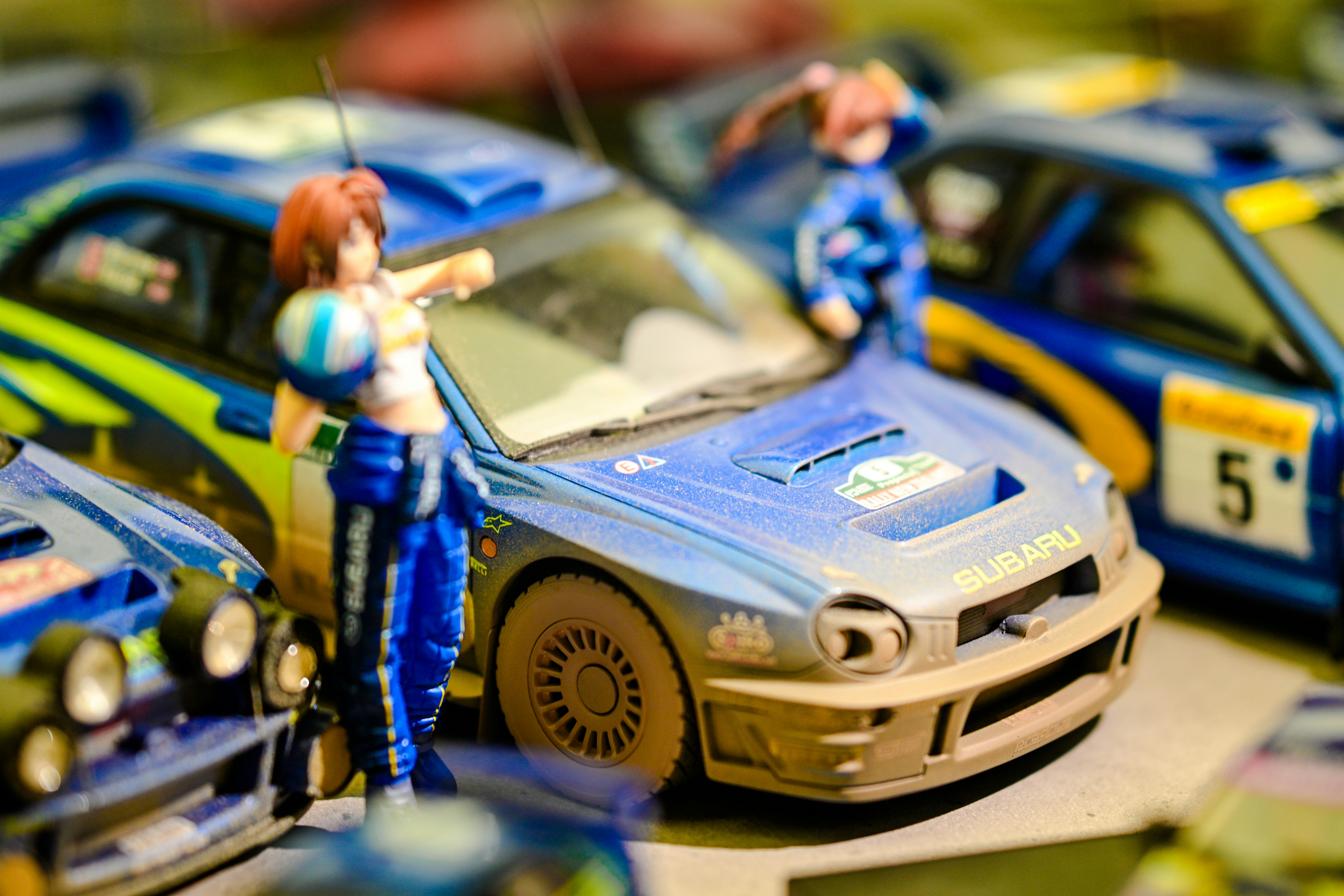 Miniature Rally Parade: Blue Subaru Leads the Pack