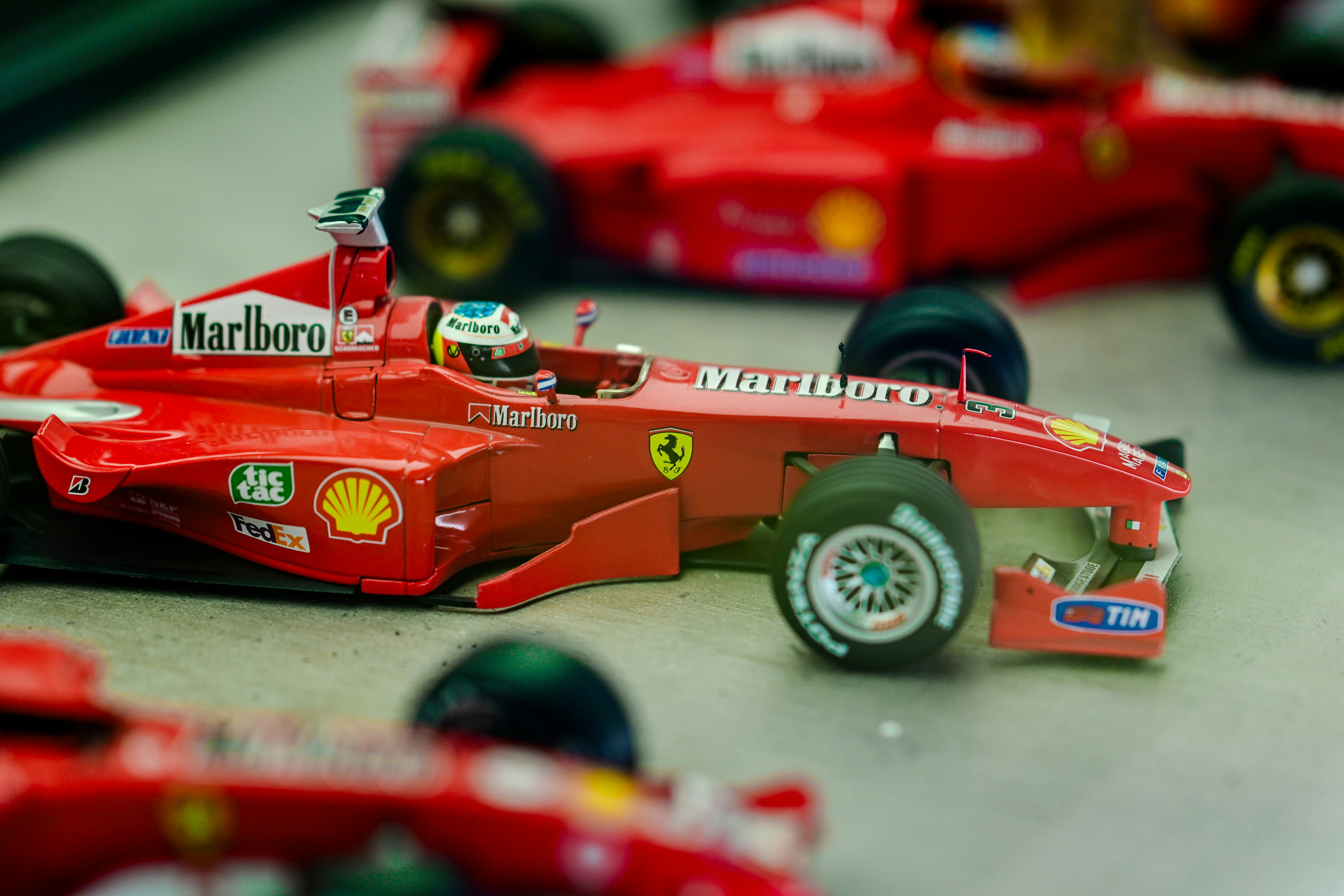 Miniature Ferrari Pit Lane: Red Cars in a Studio Display
