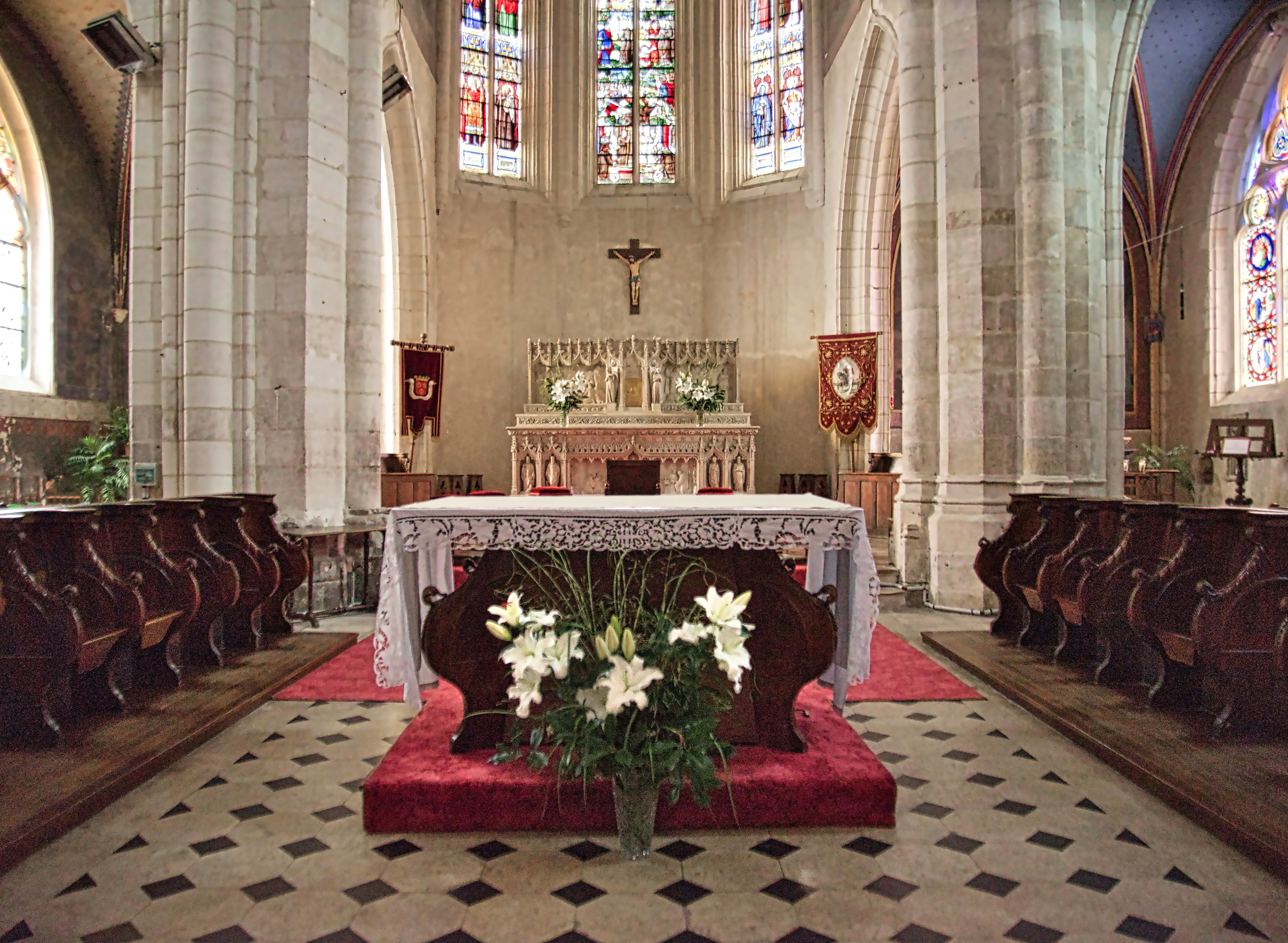 Ornate church interior with an altar and stained glass windows. photo ...
