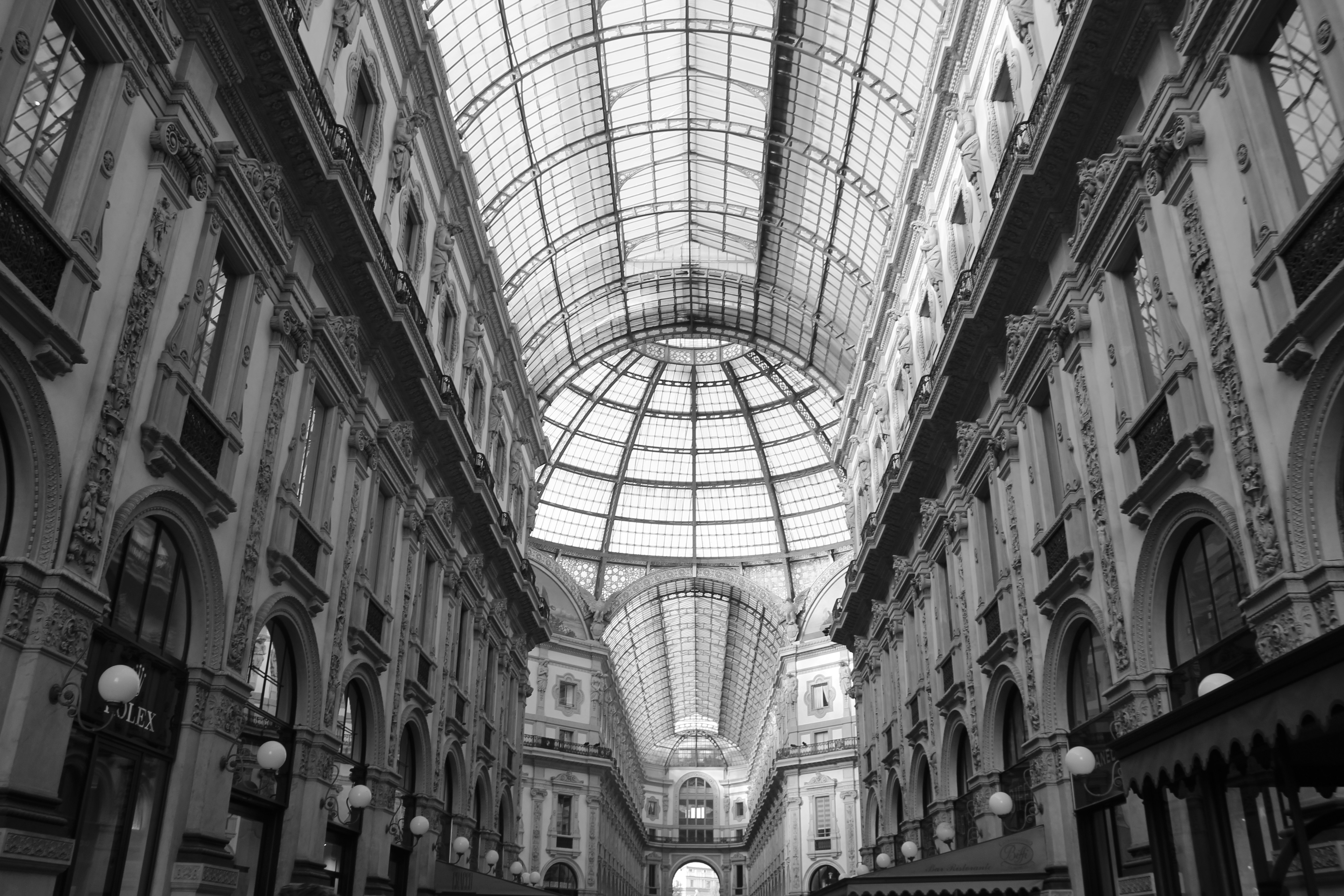 Black and white view of the historic Galleria Vittorio Emanuele II in Milan.
