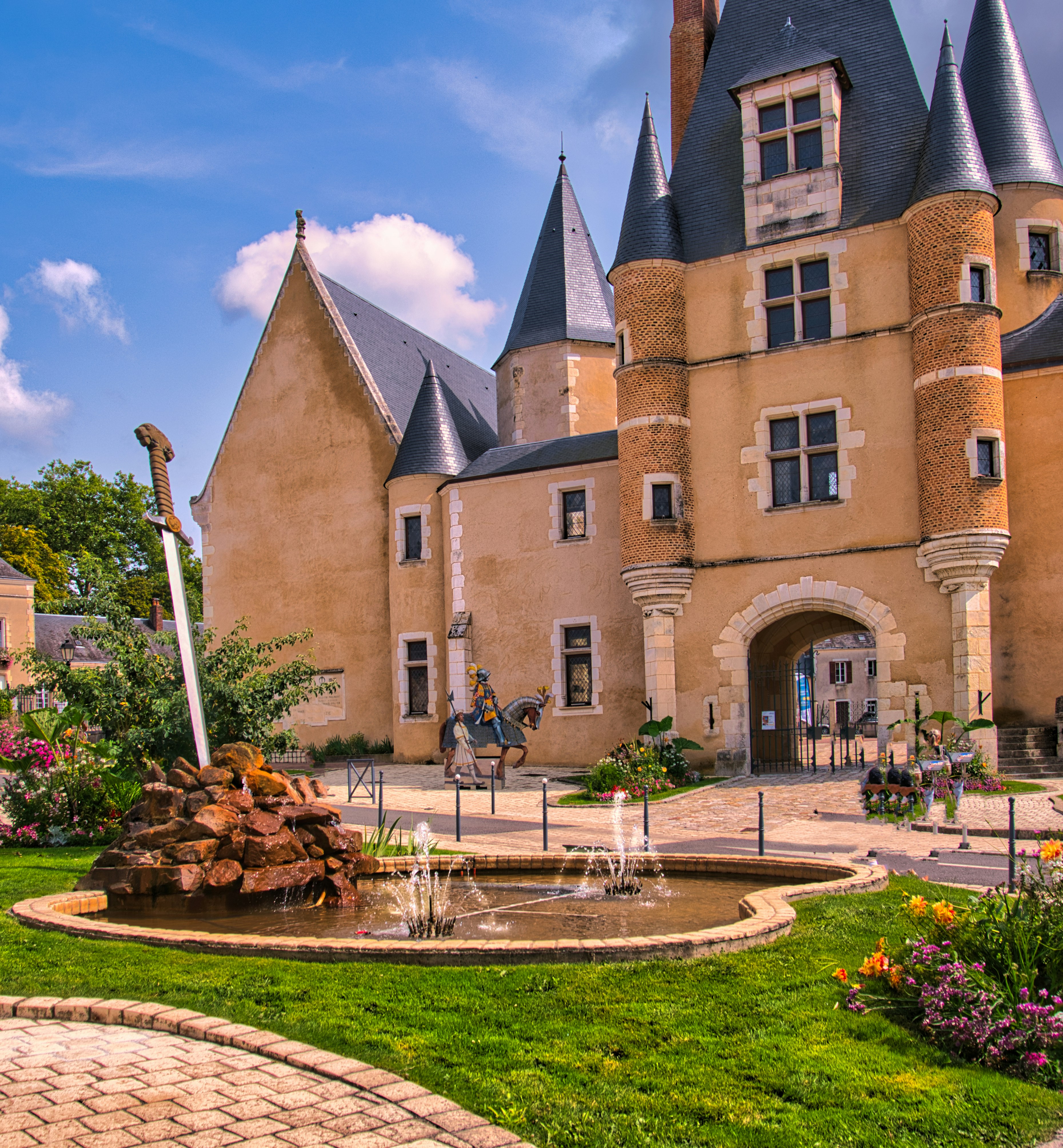 Castle Courtyard Fountain under Turrets at Golden Hour